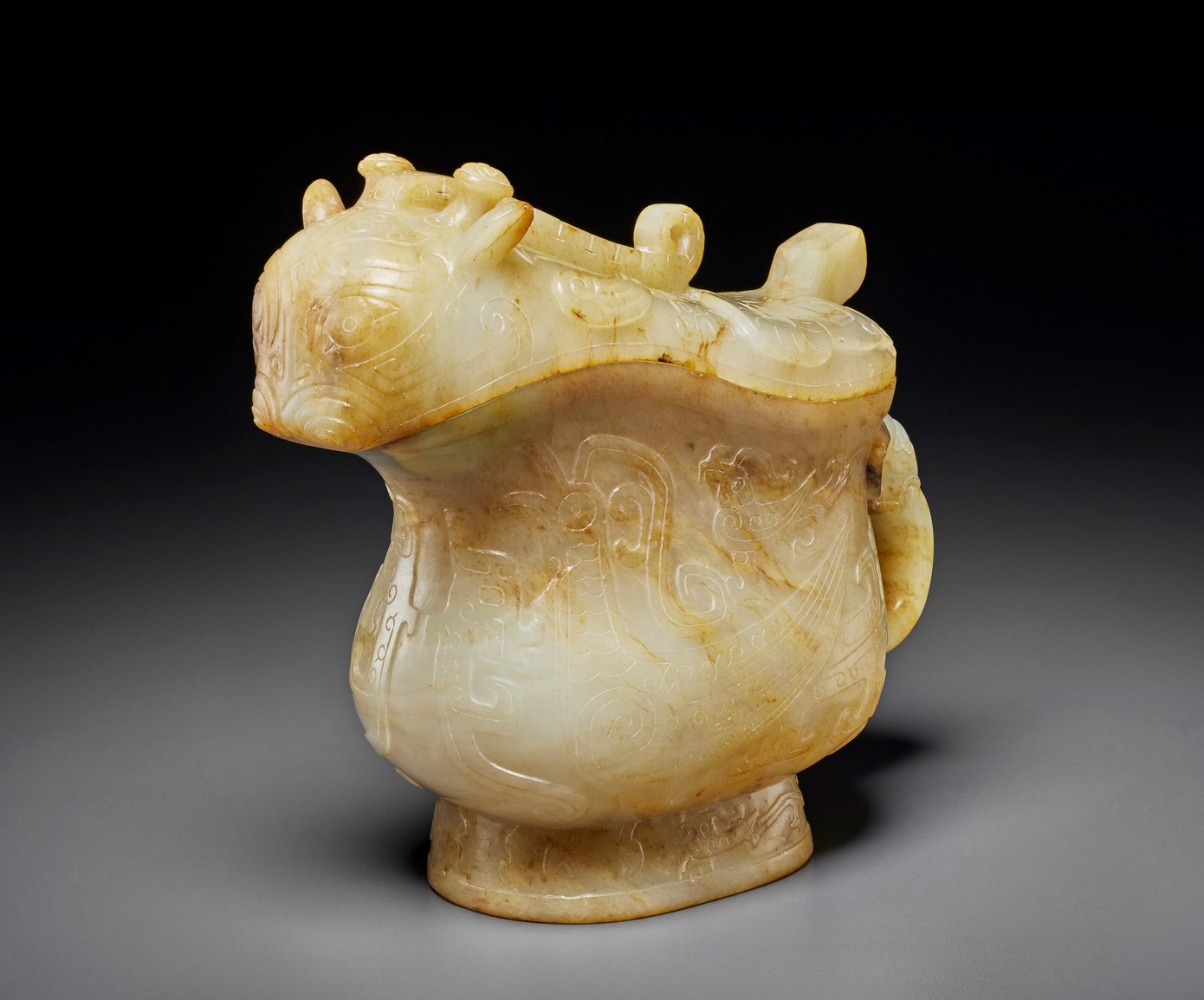 A RARE PALE BEIGE AND RUSSET JADE ARCHAISTIC GONG-FORM VESSEL AND COVER ...