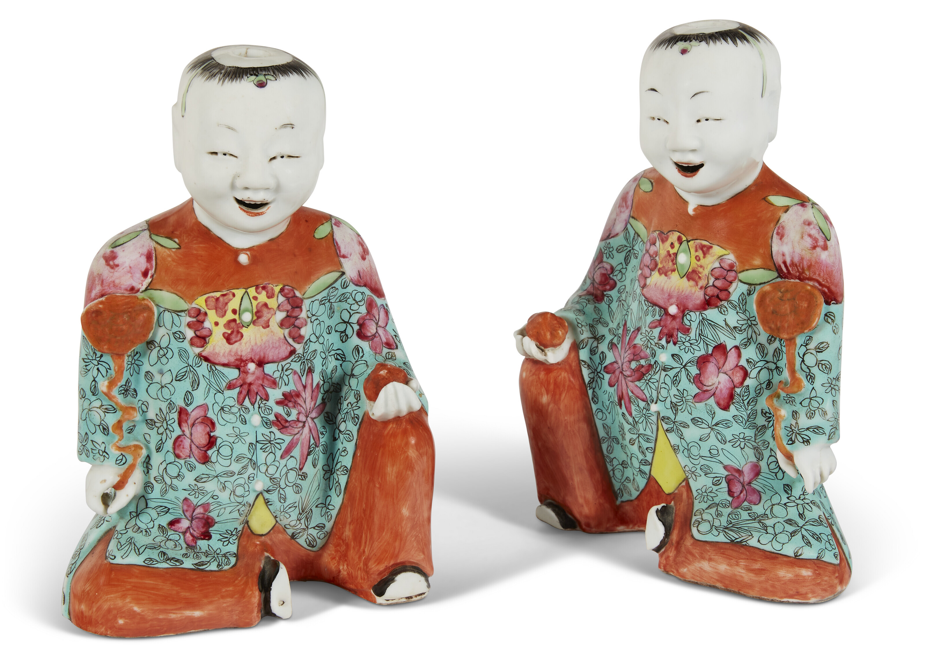 A PAIR OF CHINESE EXPORT PORCELAIN FAMILLE ROSE FIGURES OF SEATED BOYS ...