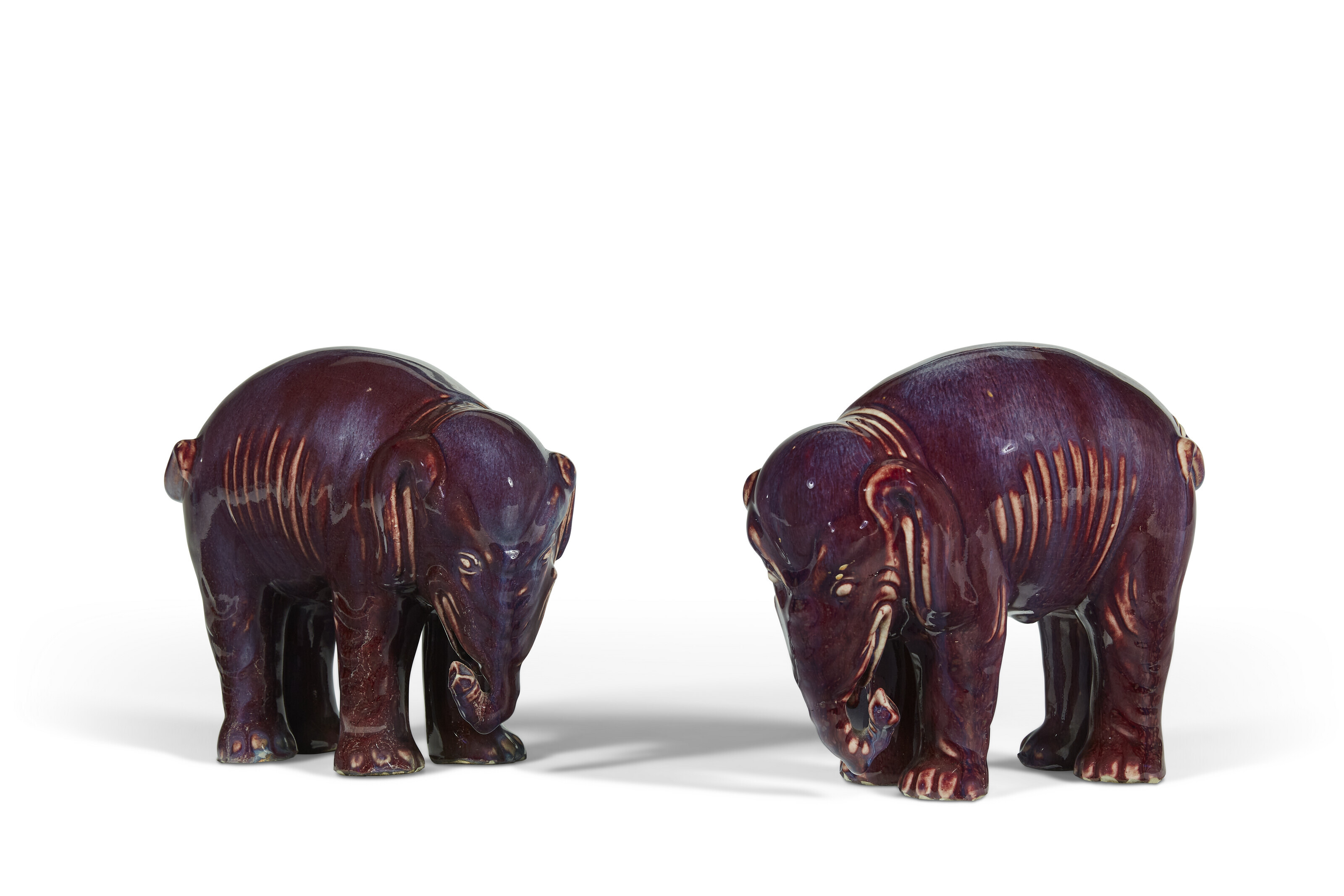 A PAIR OF CHINESE PORCELAIN FLAMBE-GLAZED ELEPHANTS, 19TH CENTURY ...