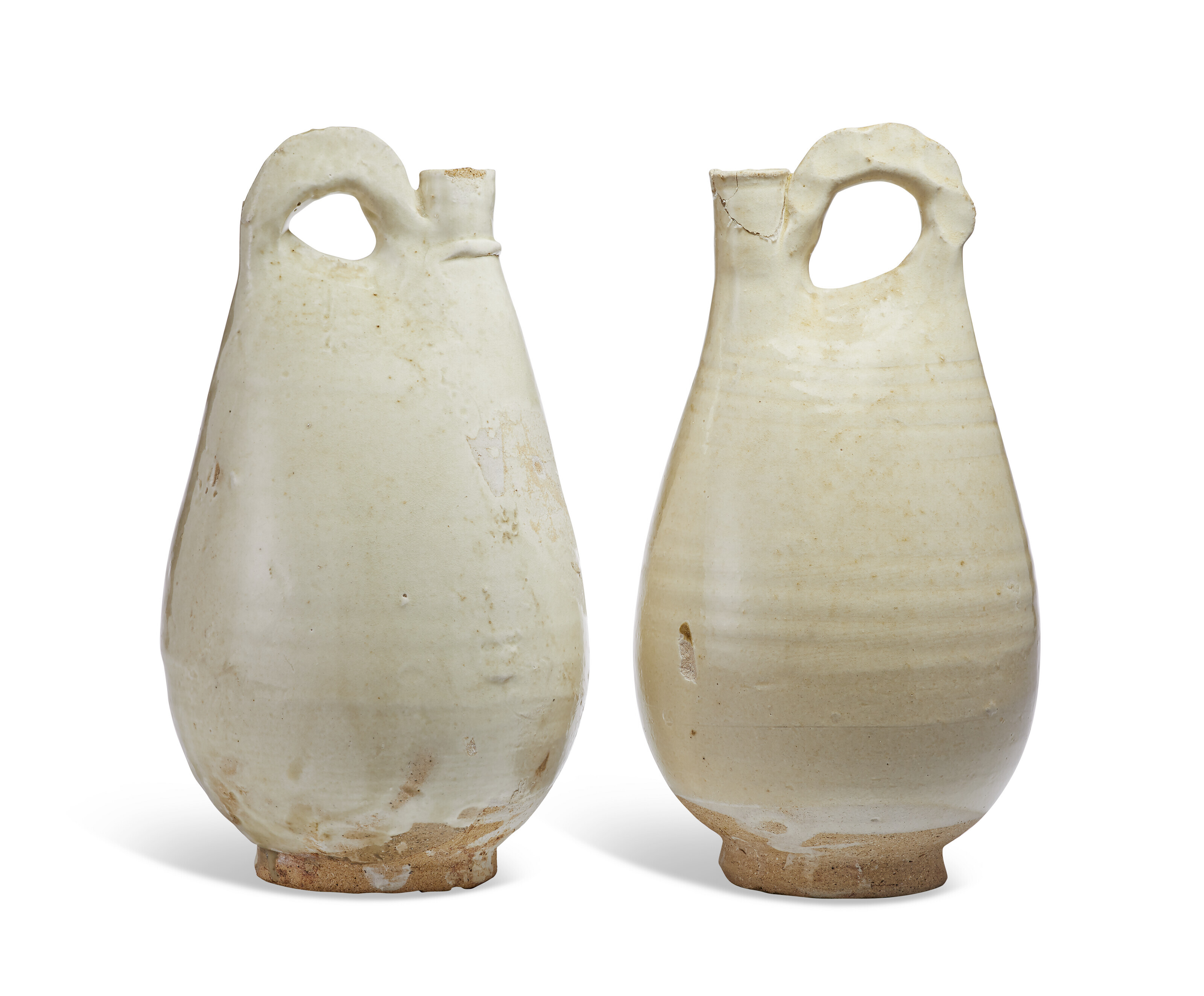 A PAIR OF WHITE-GLAZED POTTERY FLASKS, LIAO DYNASTY (AD 907-1125 ...