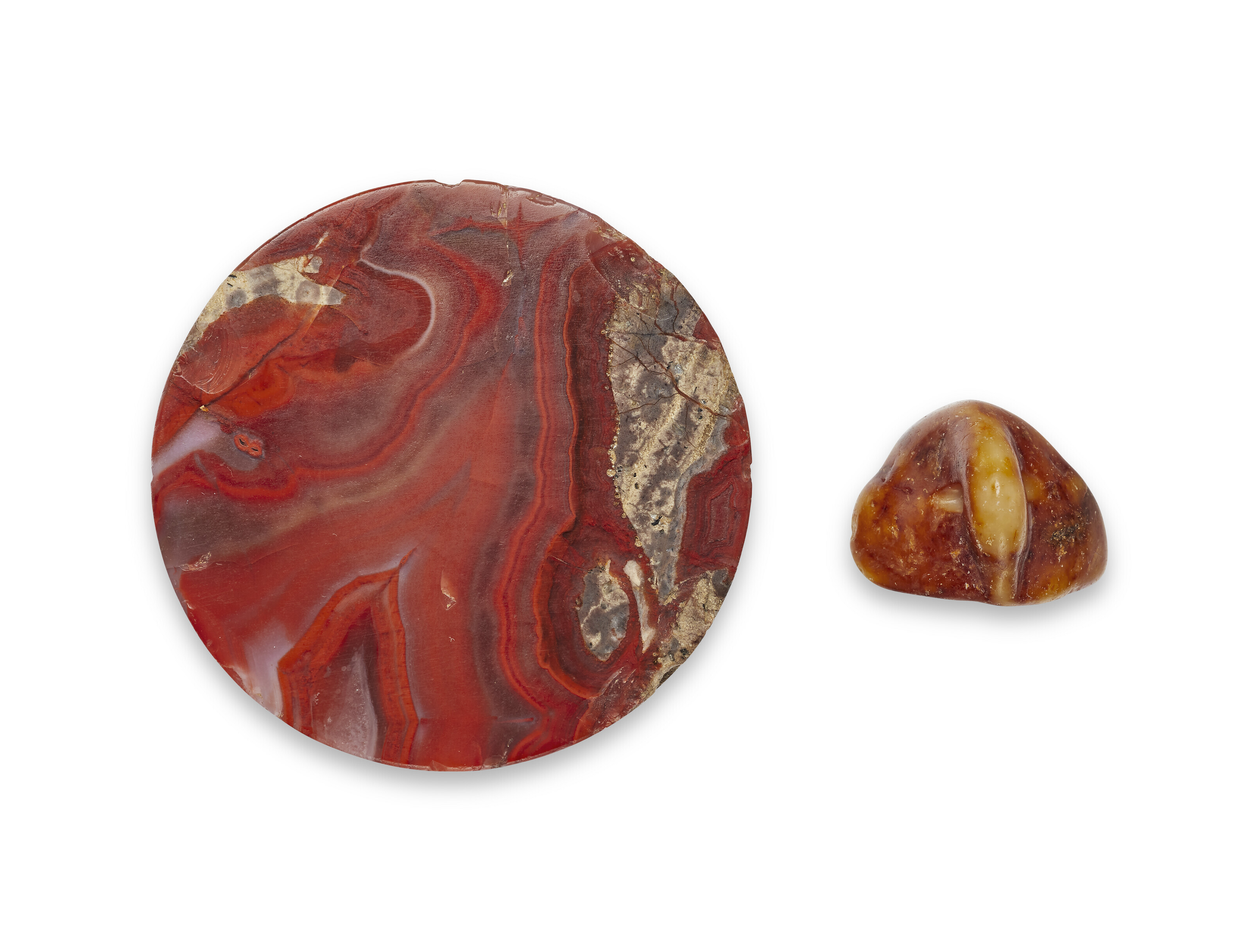 A MOTTLED RED AGATE CIRCULAR SWORD POMMEL, HAN DYNASTY (206 BC-AD 220 ...