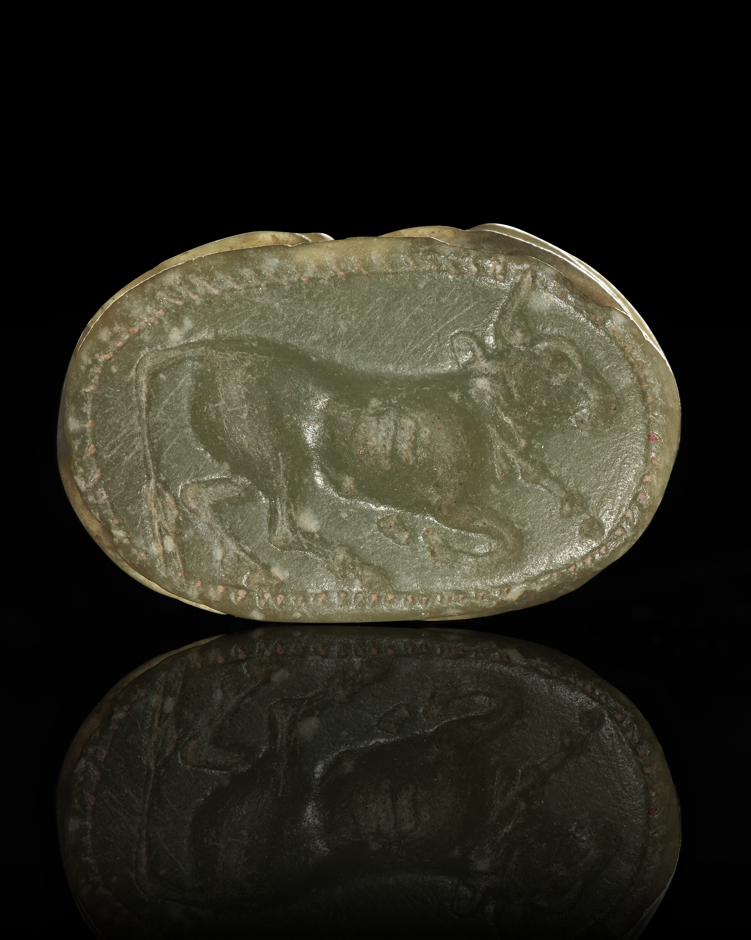 A GREEK GREEN SERPENTINE ISLAND SCARAB WITH A BULL, ATTRIBUTED TO ...