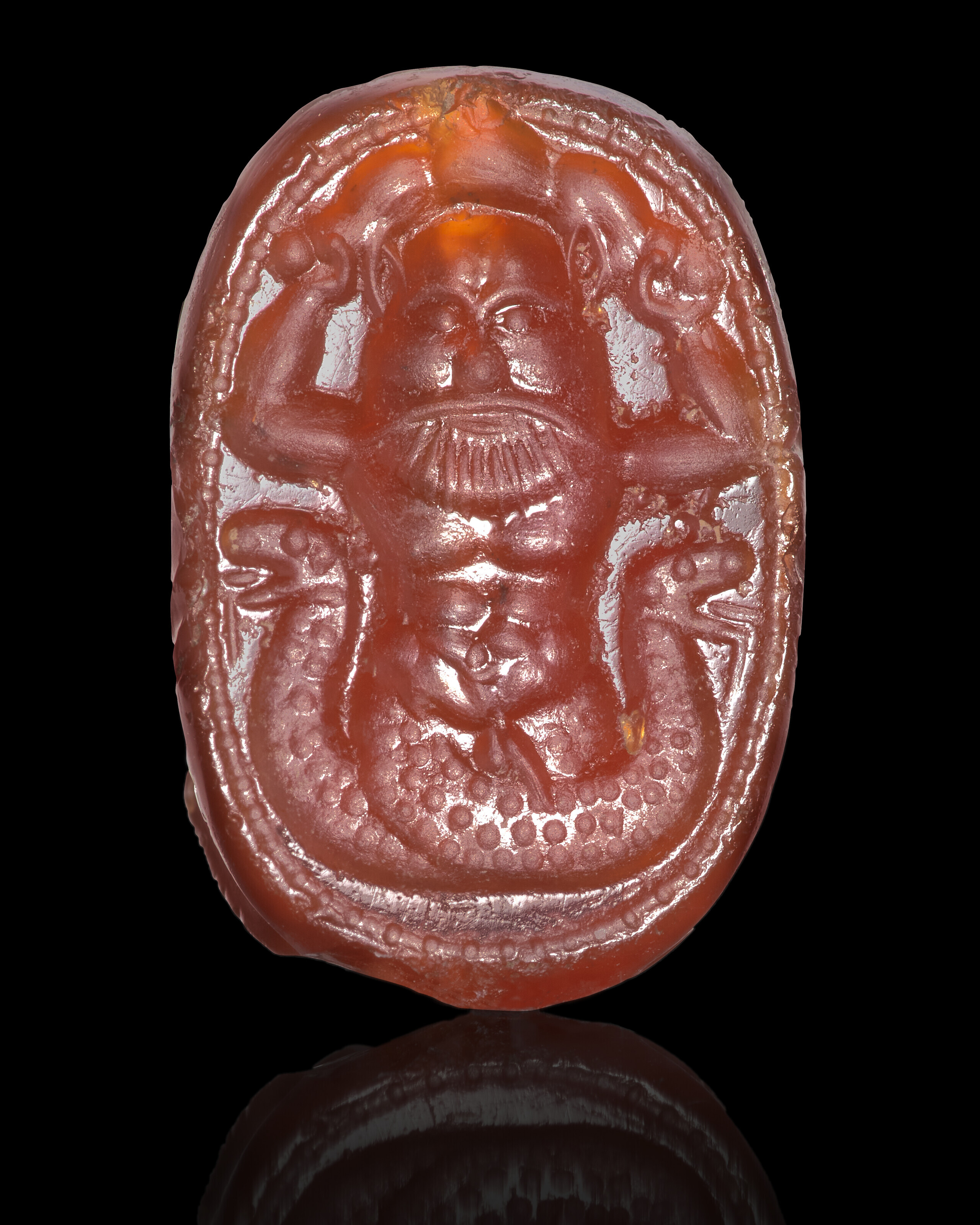 A GREEK CARNELIAN SCARAB WITH A MONSTER, ARCHAIC PERIOD, CIRCA 500 B.C ...