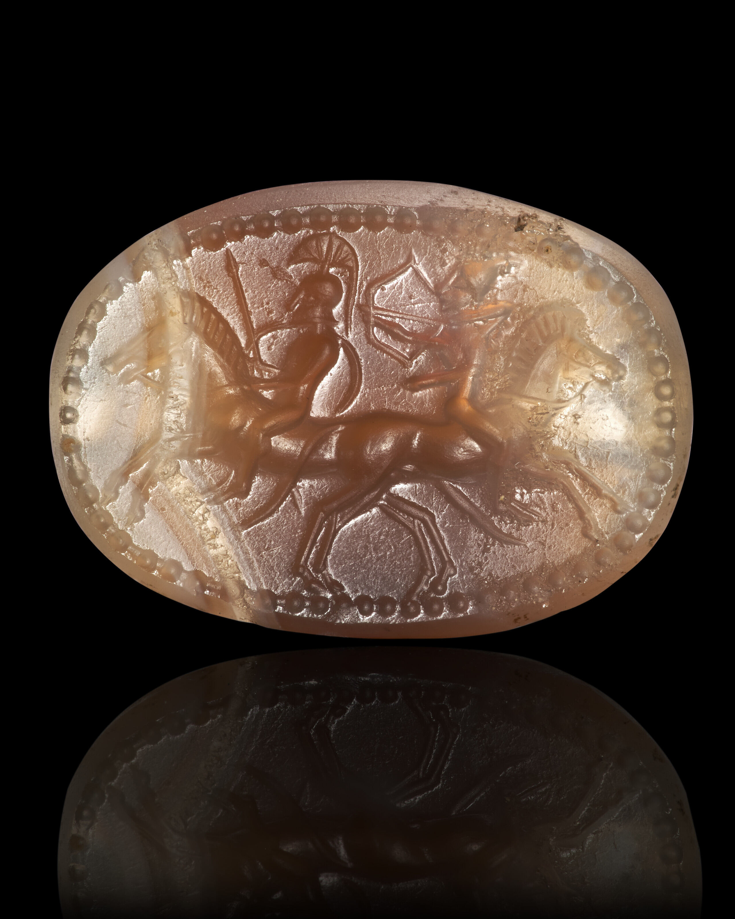 A GREEK BANDED AGATE RINGSTONE WITH TWO HORSEMEN, ARCHAIC PERIOD, CIRCA ...