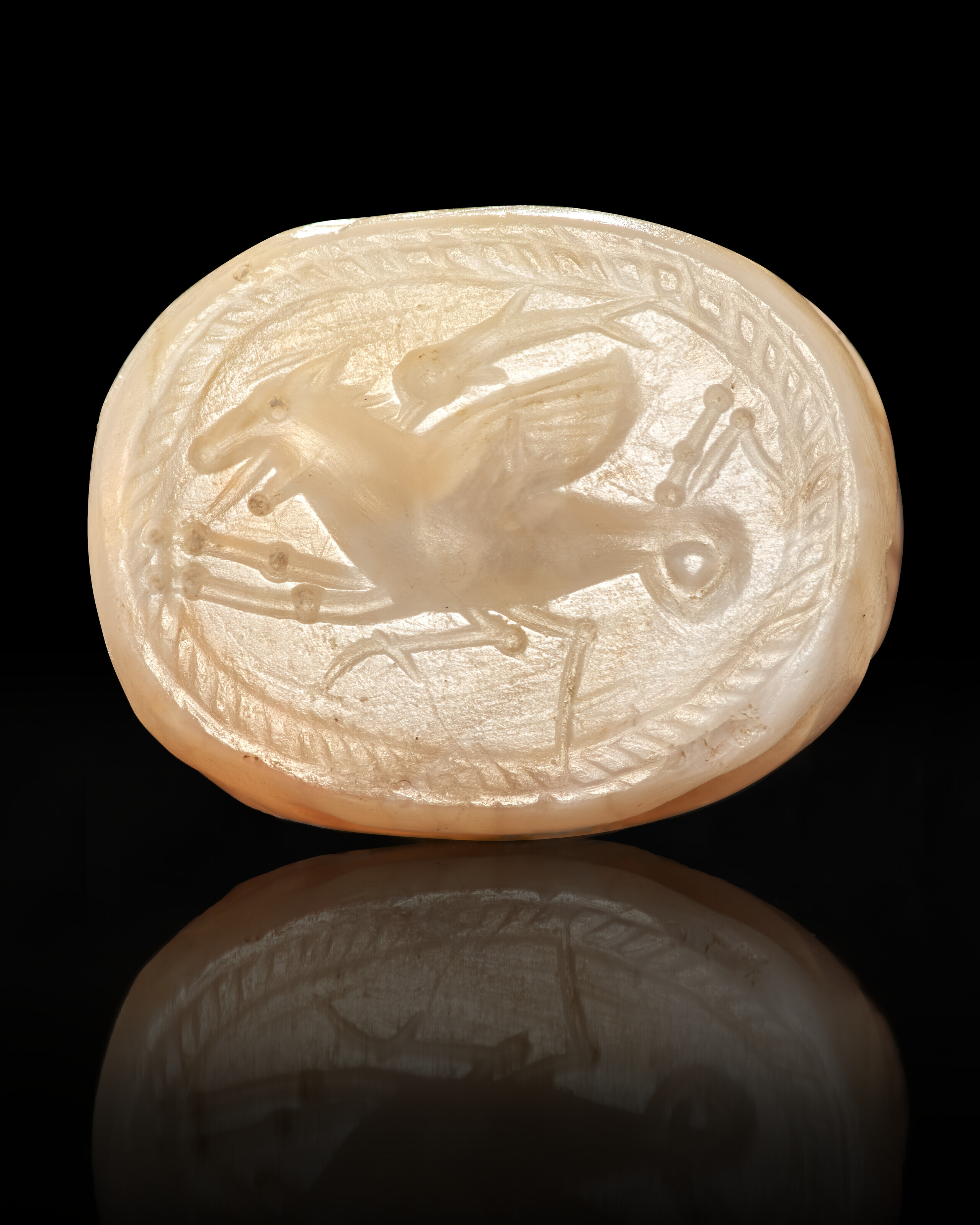 A GREEK BANDED AGATE SCARAB WITH A MONSTER, ARCHAIC PERIOD, CIRCA 500 B ...