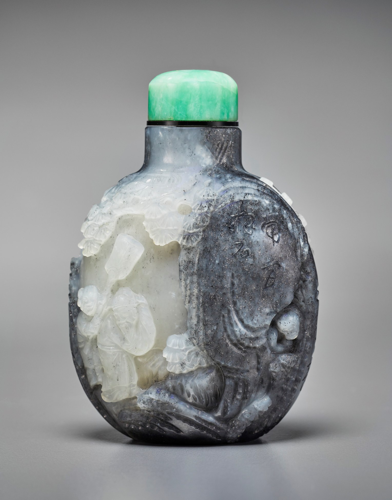 A RARE AND FINELY CARVED BLACK AND WHITE JADE SNUFF BOTTLE, SUZHOU ...