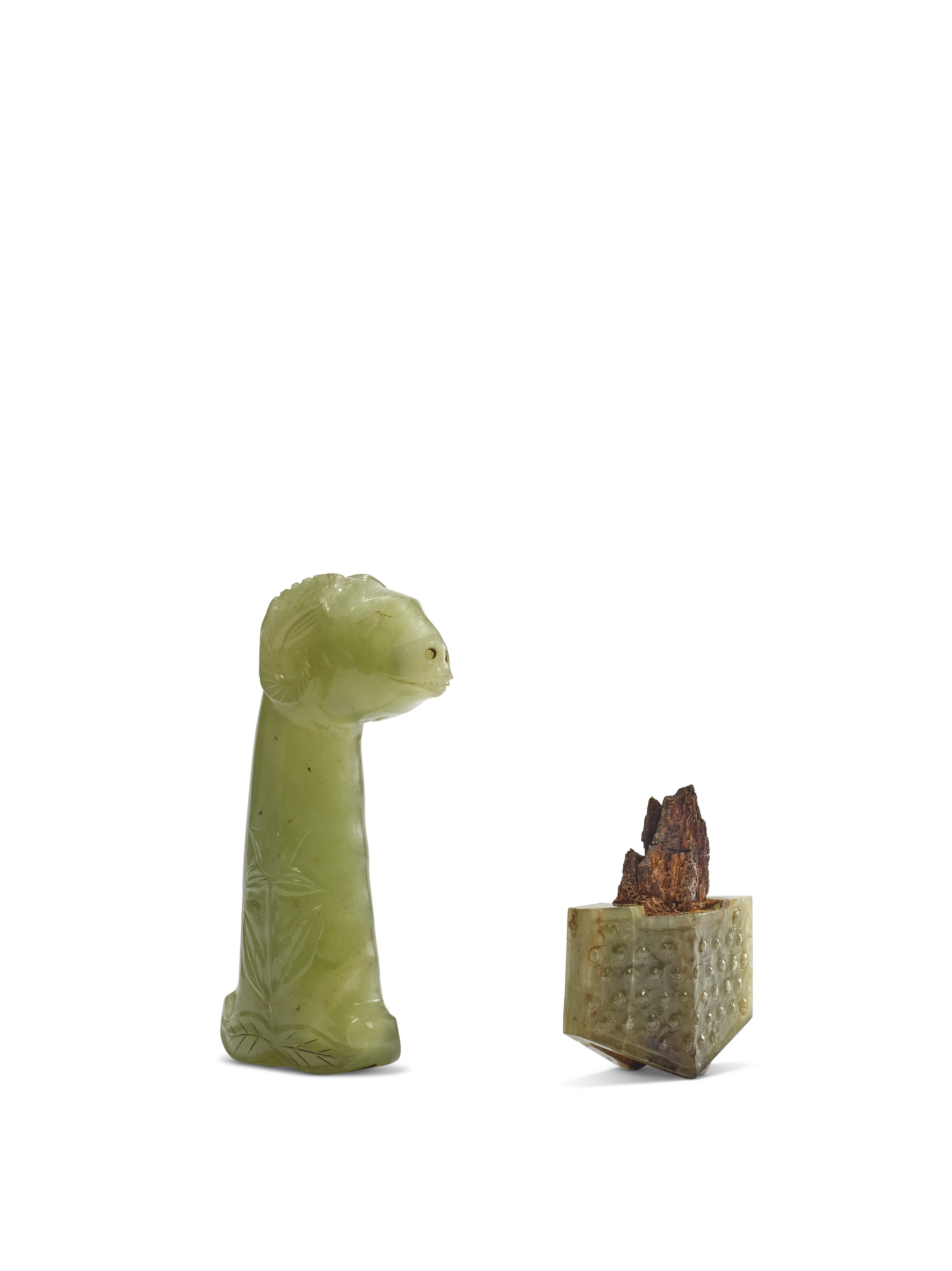 A GREEN JADE 'RAM' DAGGER HANDLE AND A CELADON JADE SWORD CHAPE, THE ...