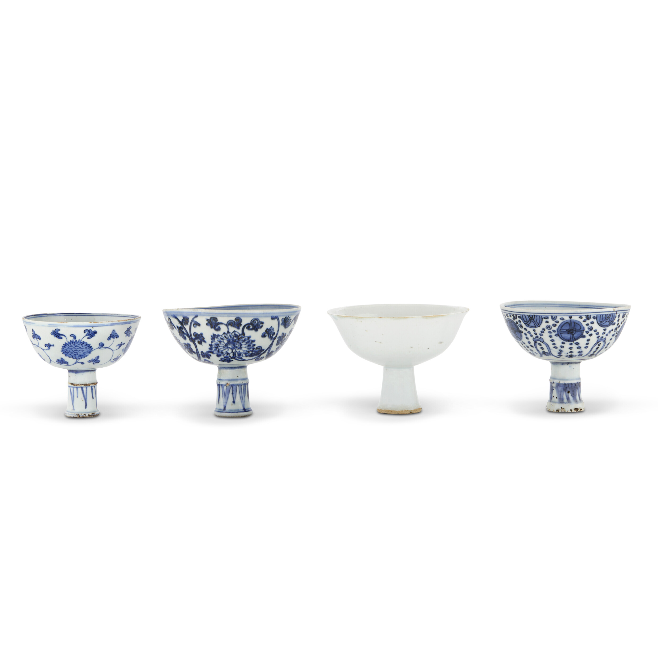 THREE BLUE AND WHITE STEM CUPS AND A WHITE-GLAZED MOULDED STEM CUP ...