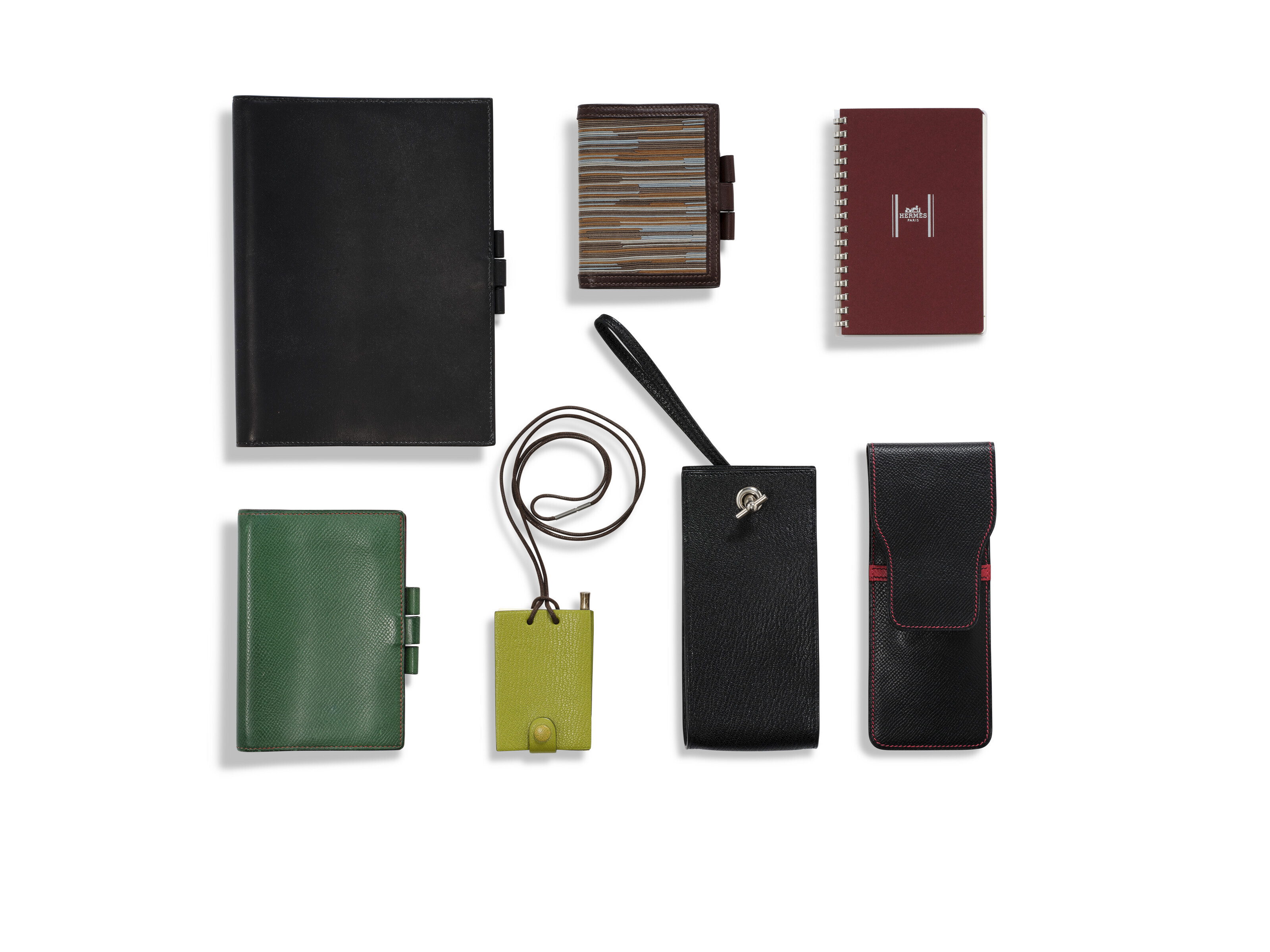 A GROUP OF SIX: A NOTEBOOK NECKLACE, THREE AGENDA COVERS, A POUCH, & A ...