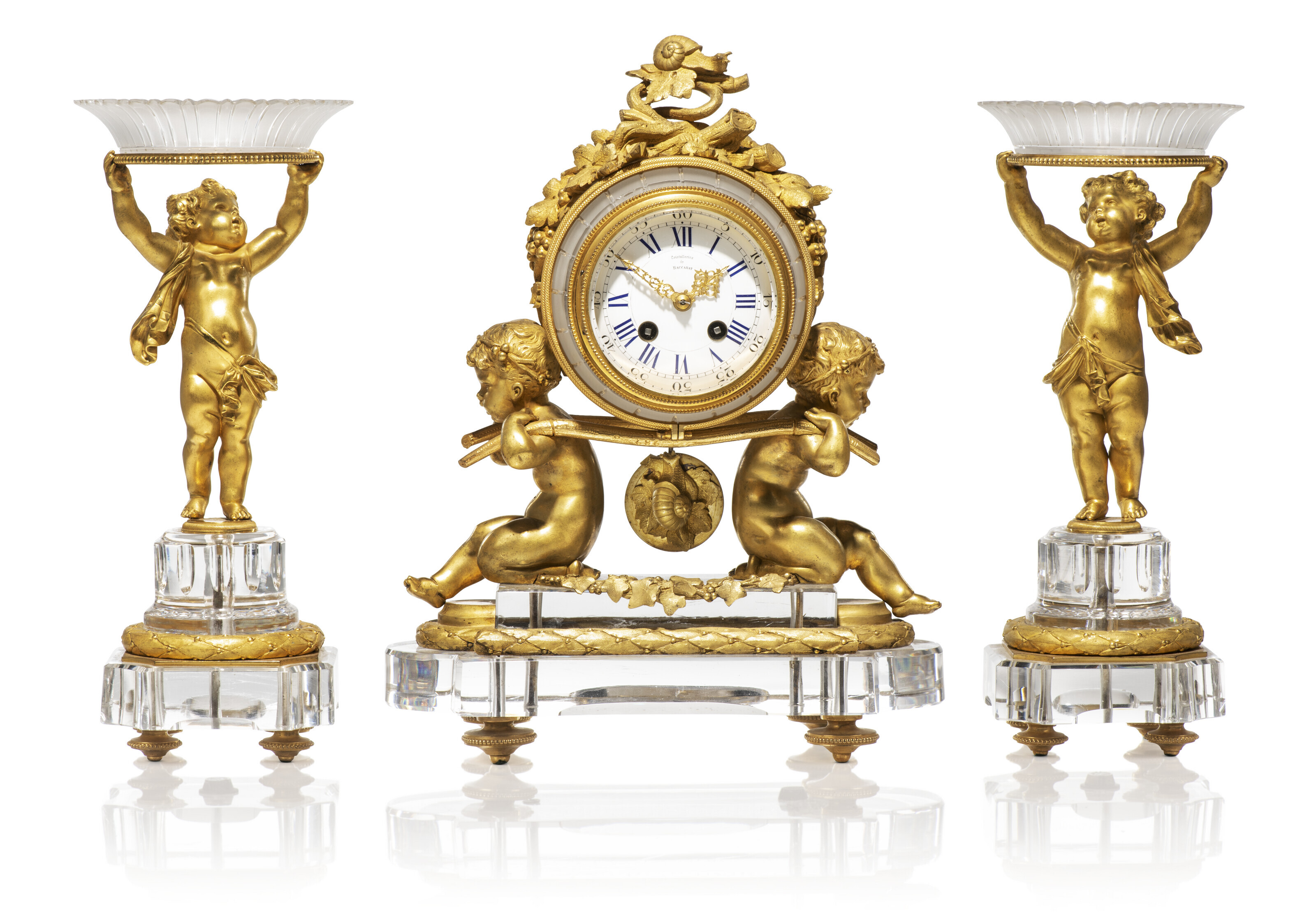 A FRENCH ORMOLU-MOUNTED CUT-CRYSTAL CLOCK GARNITURE, BY CRISTALLERIES ...