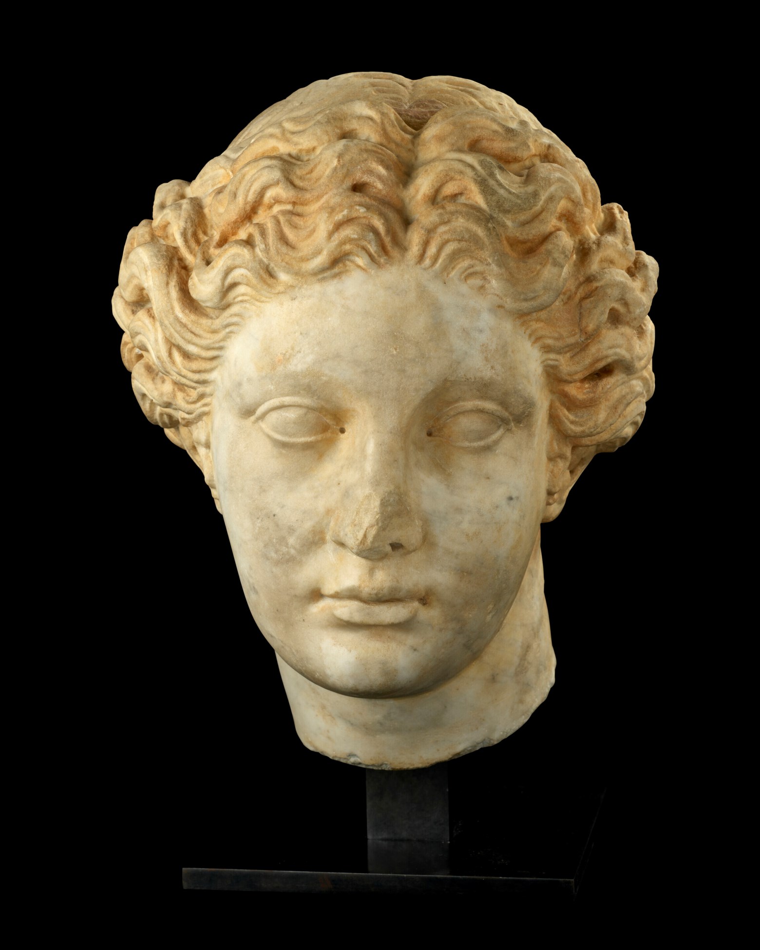 A ROMAN MARBLE HEAD OF A GODDESS