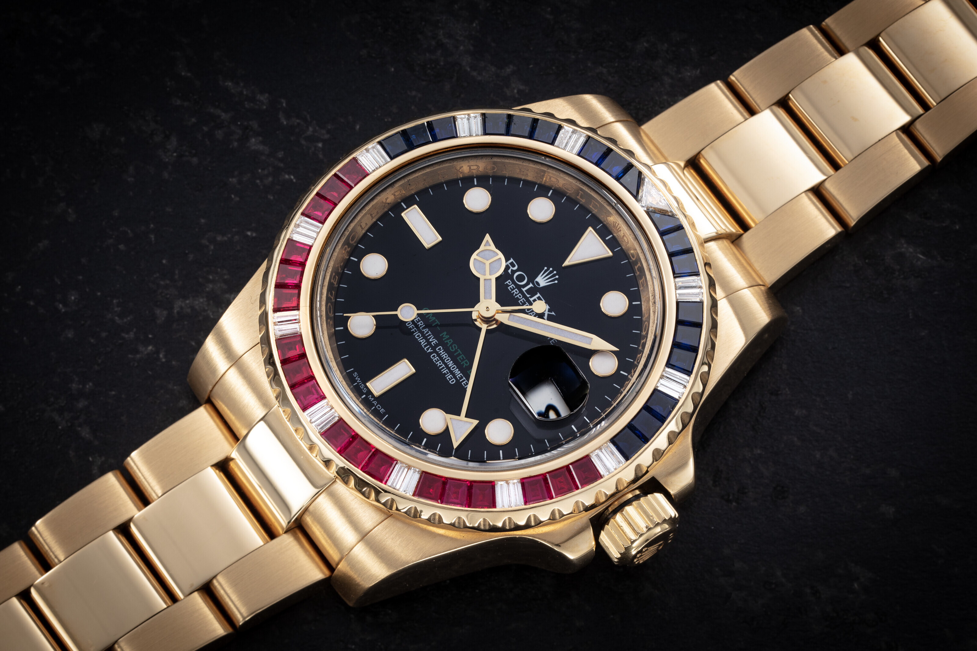 ROLEX, GMT-MASTER II SARU REF. 116748, A GOLD RUBY, SAPPHIRE, AND ...