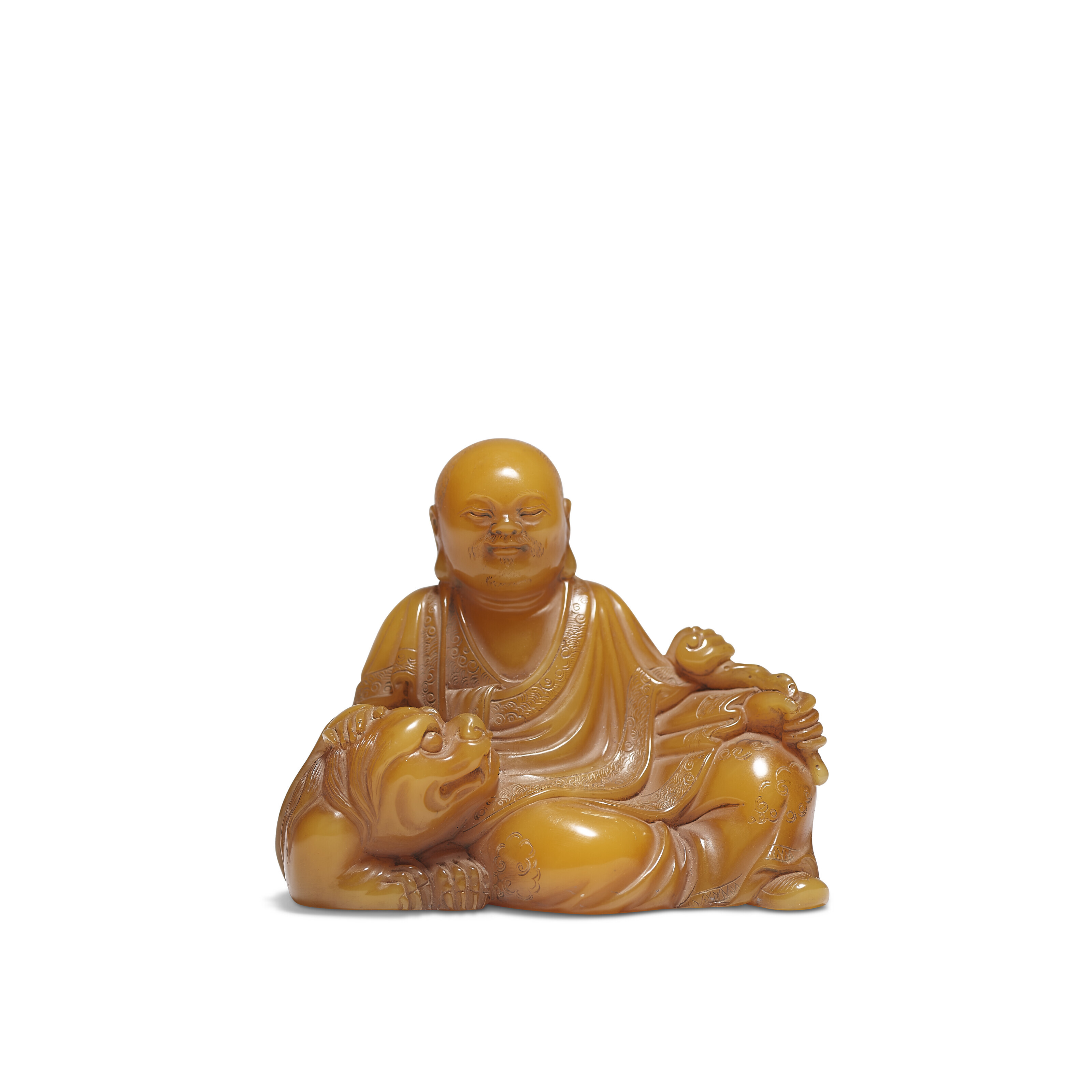 A SHOUSHAN CARVING OF A SEATED LUOHAN WITH A LION, | Christie’s