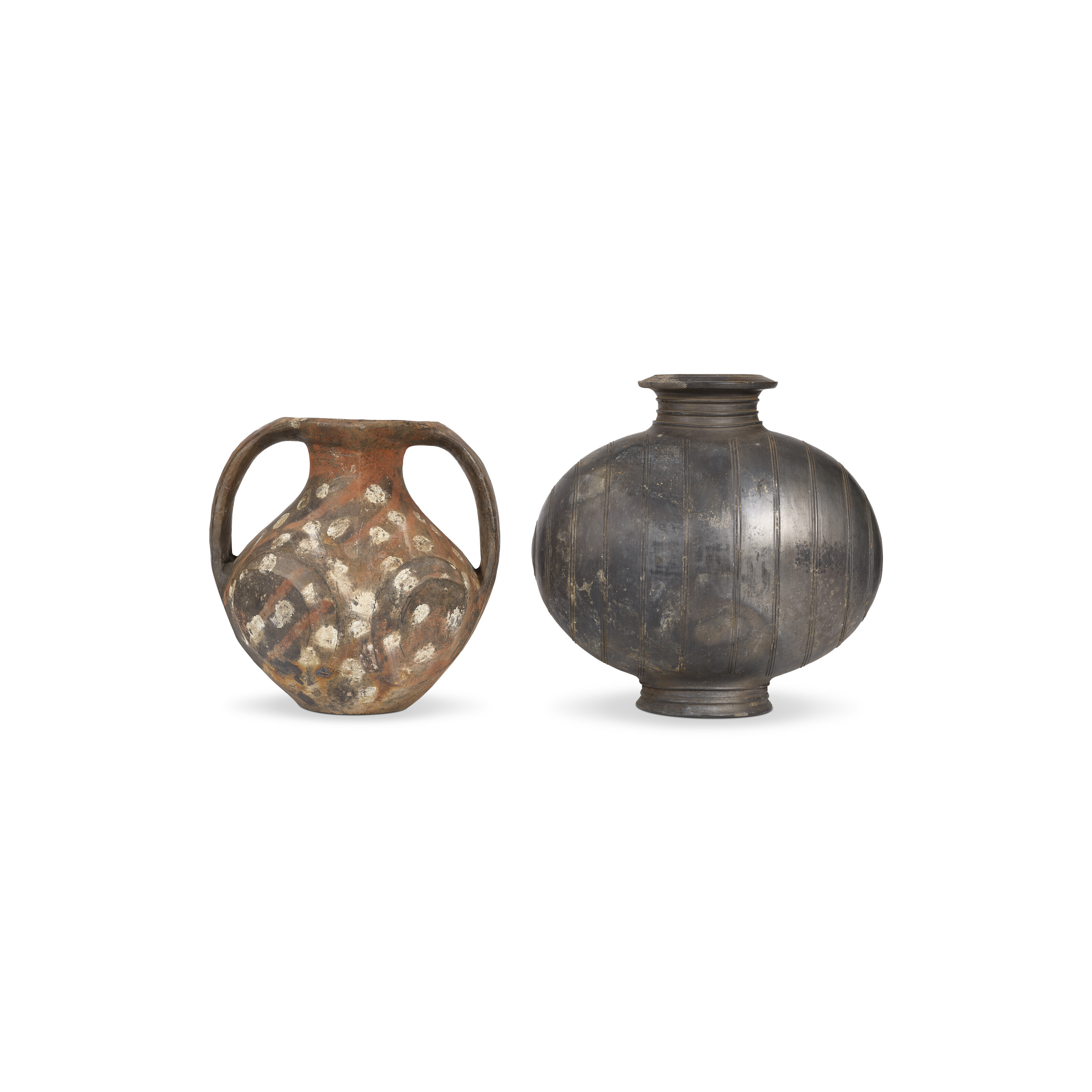 A TWIN-HANDLED PAINTED BLACK POTTERY JAR AND A LARGE GREY POTTERY ...