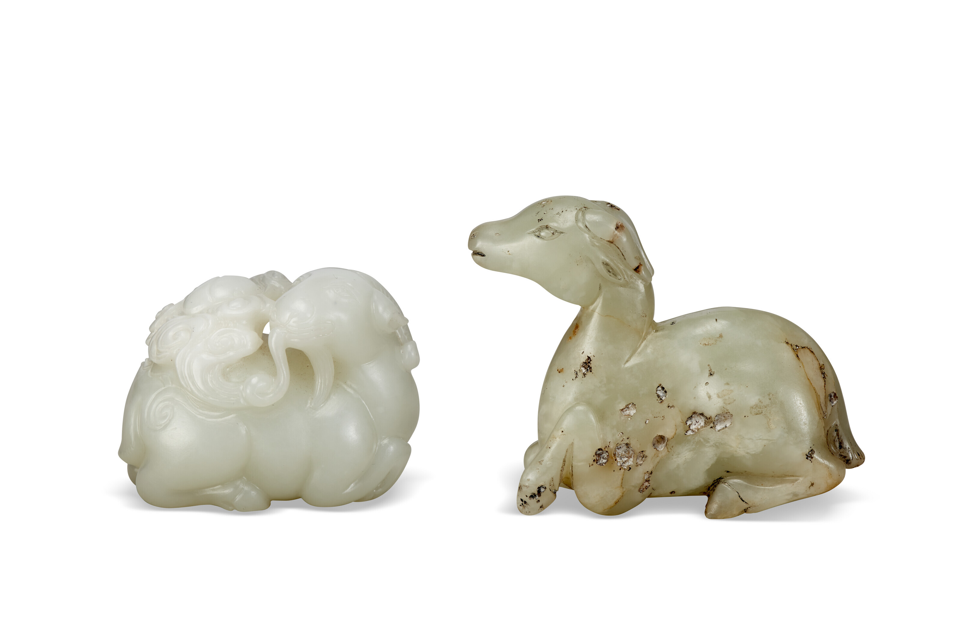 A WHITE JADE CARVING OF A RAM AND A GREENISH-BEIGE JADE CARVING OF A ...