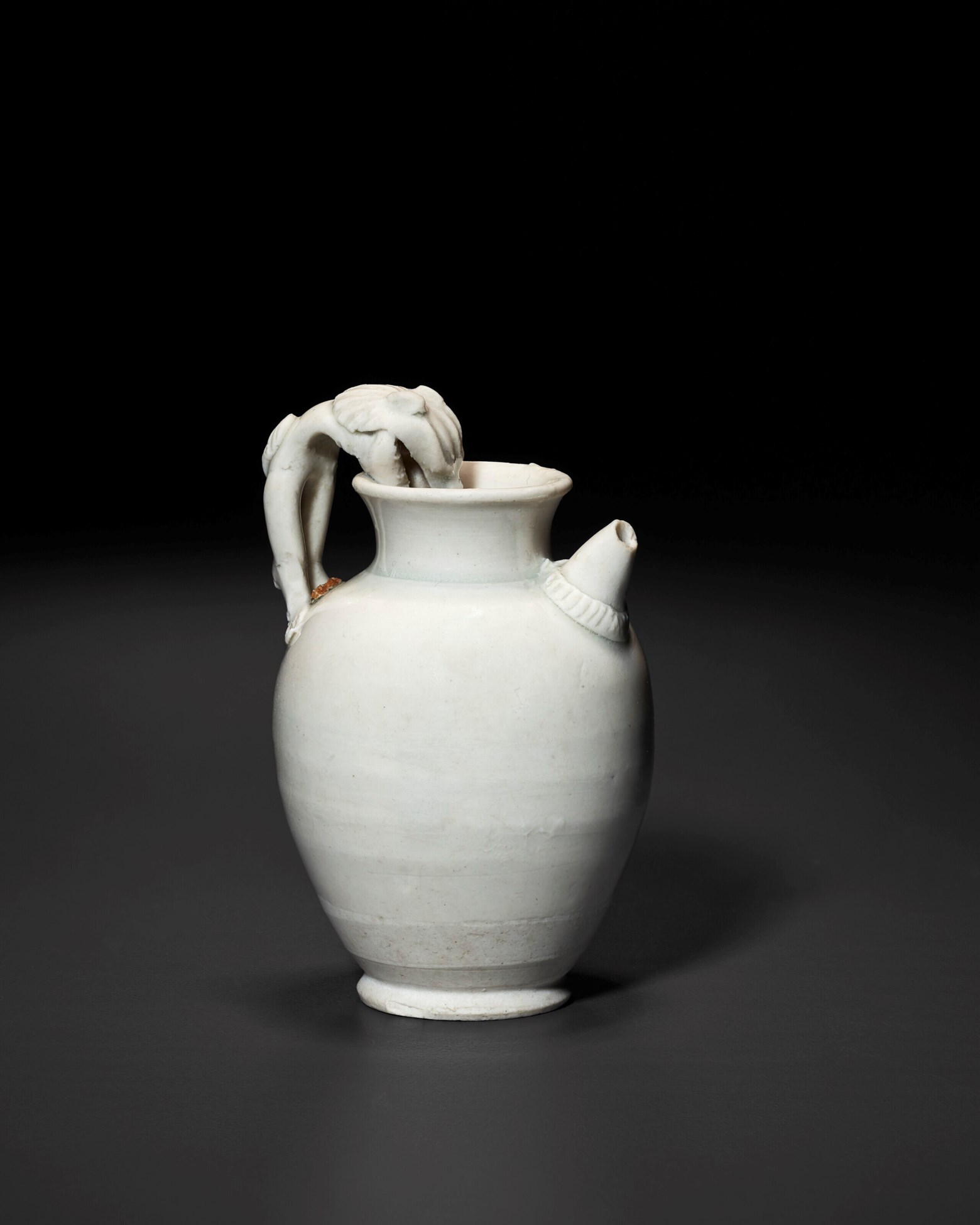 A RARE SMALL GLAZED WHITE WARE LION-HANDLED EWER, TANG DYNASTY, 9TH ...