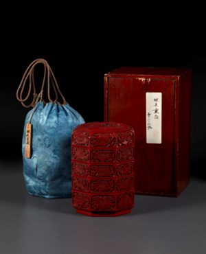 A CARVED RED LACQUER OCTAGONAL FOUR-TIERED BOX AND COVER