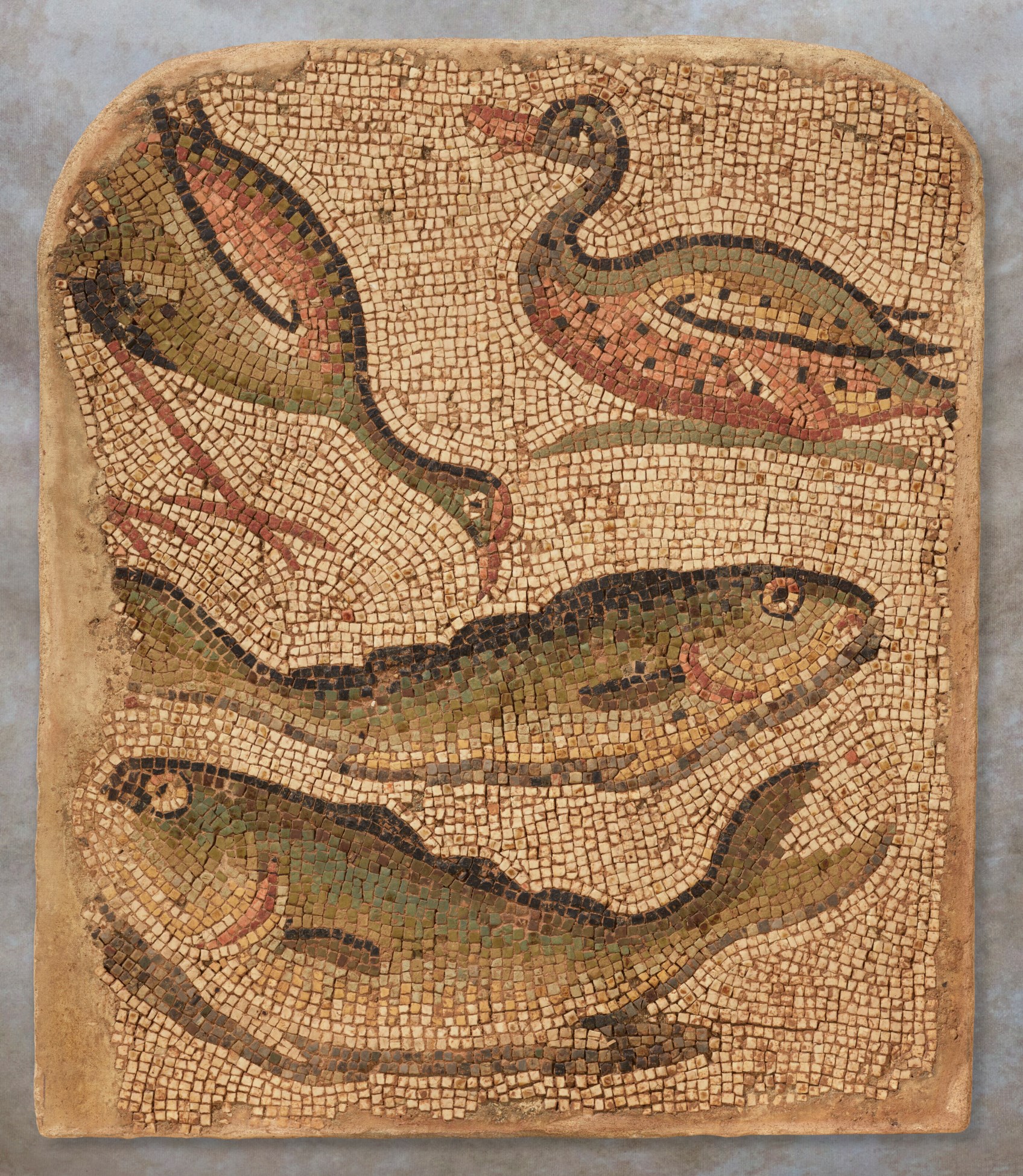 A BYZANTINE MARBLE MOSAIC PANEL WITH TWO FISH, A DUCK AND A BIRD, CIRCA ...