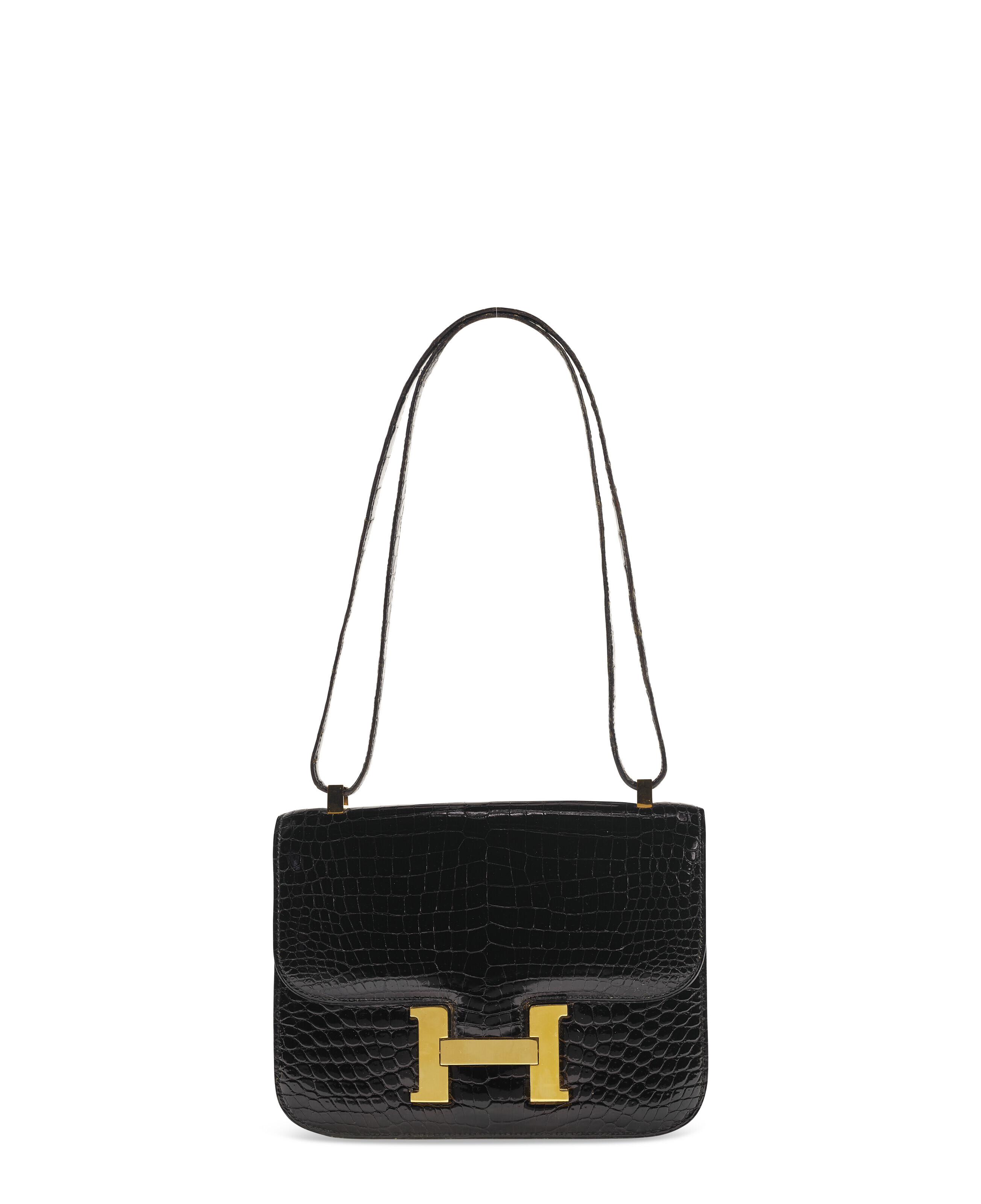 A SHINY BLACK POROSUS CROCODILE CONSTANCE 23 WITH GOLD HARDWARE, HERMÈS ...