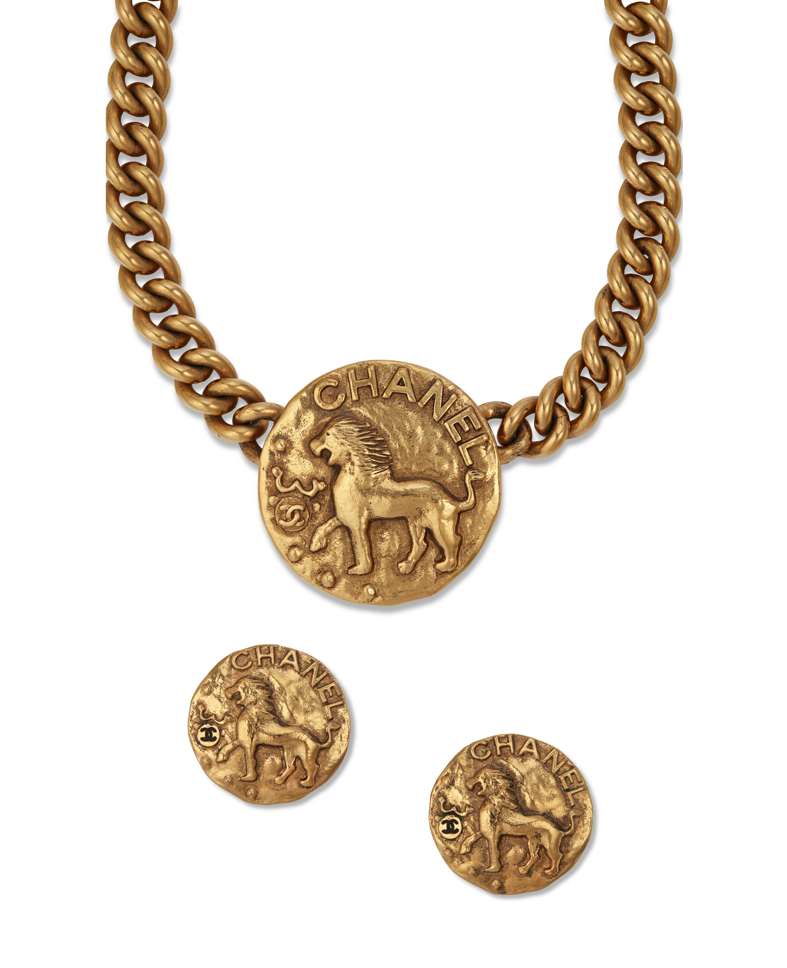 A SET OF TWO: A LEO COIN GOLD-PLATED METAL CHOKER & MATCHING EARRINGS ...