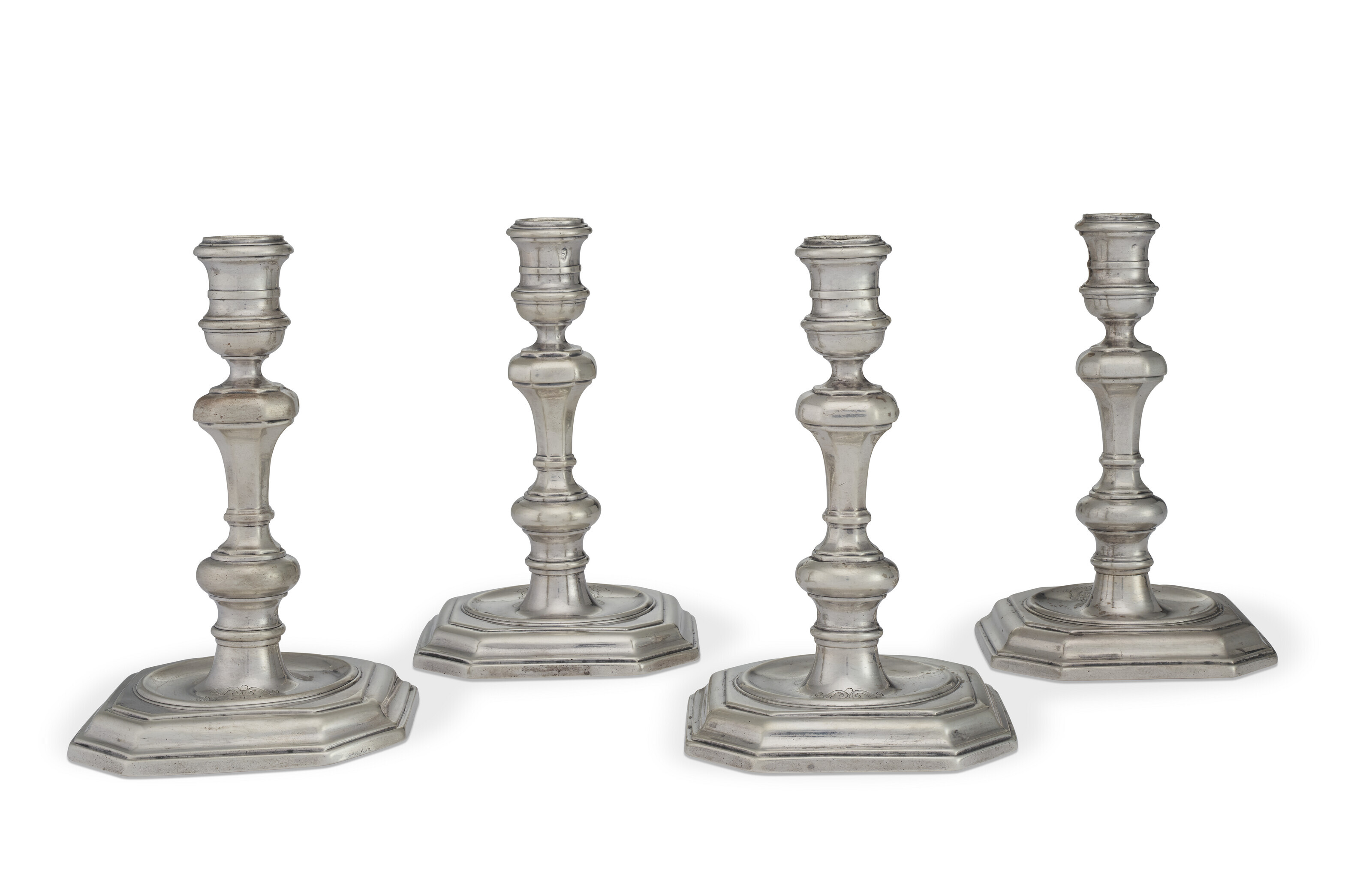 A SET OF FOUR QUEEN ANNE SILVER CANDLESTICKS, MARK OF PAUL DE LAMERIE ...