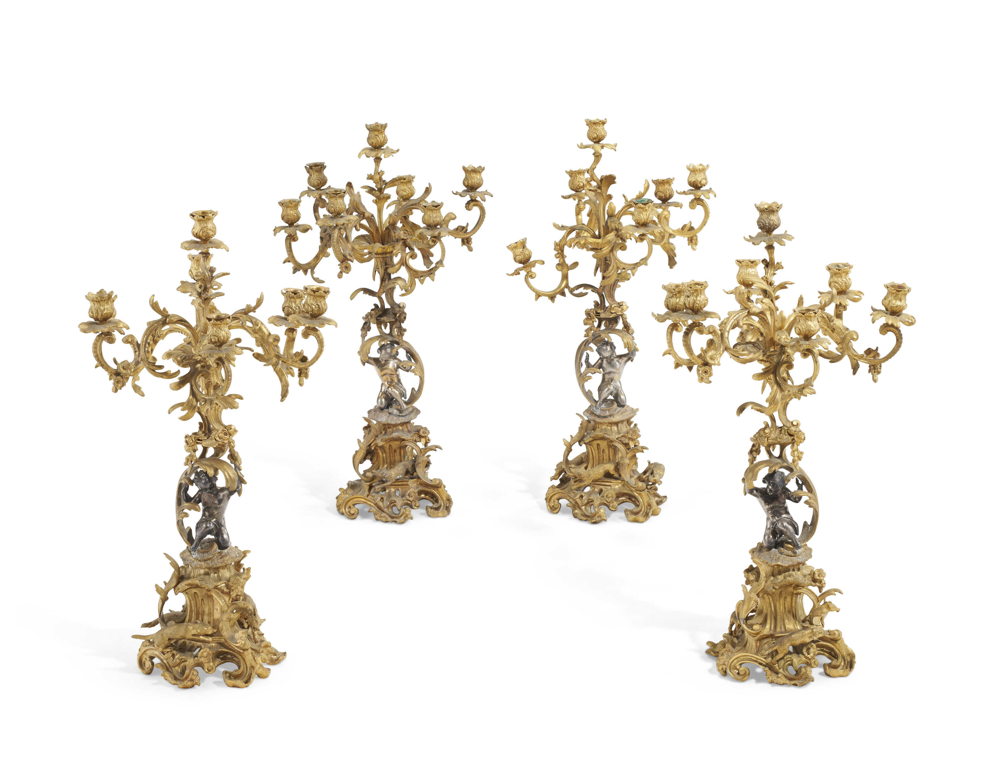 A SET OF FOUR NAPOLEON III GILT AND SILVERED-BRONZE SEVEN-LIGHT ...