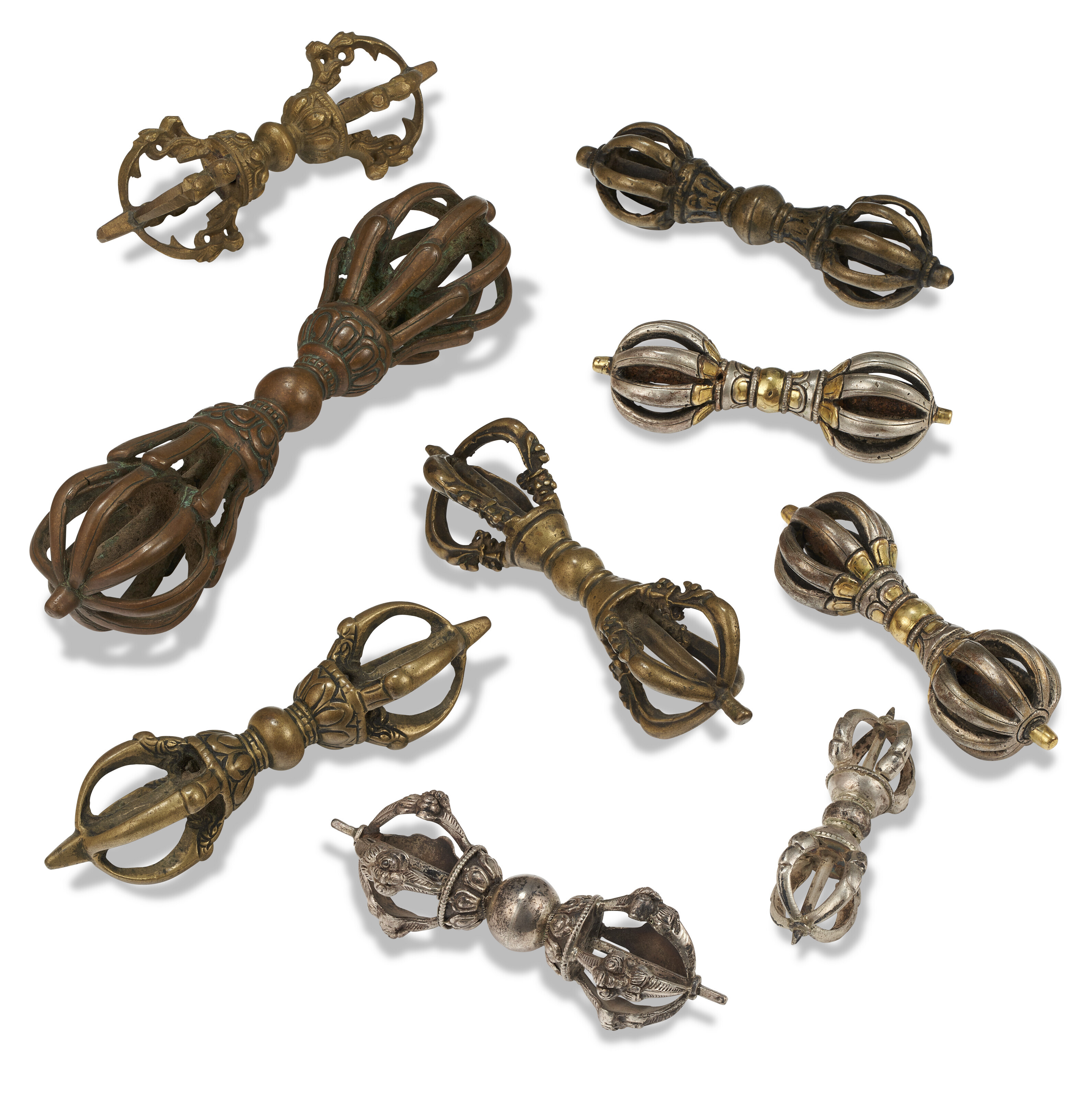 A GROUP OF NINE MIXED METAL VAJRAS, TIBET, 17TH CENTURY AND LATER ...