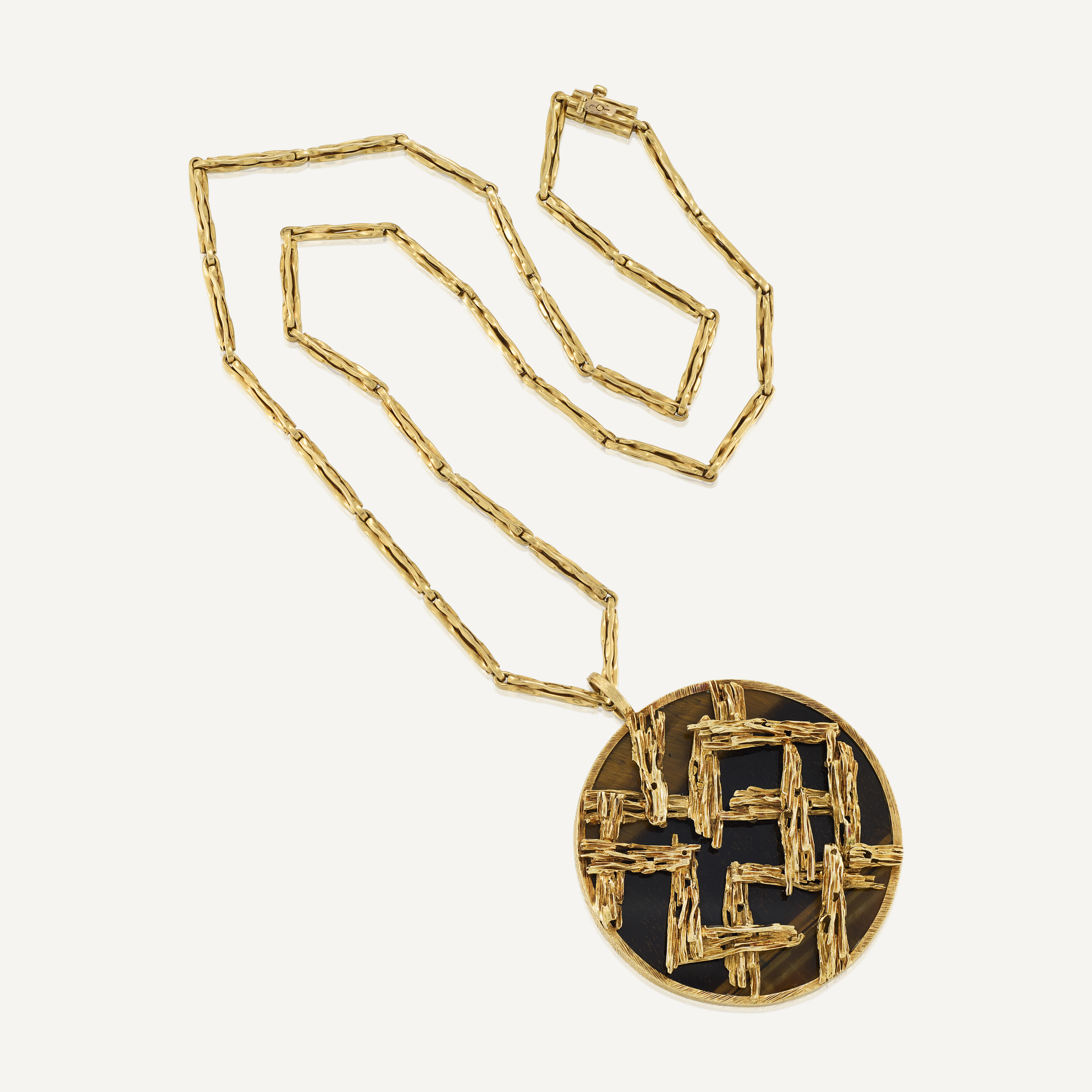 NO RESERVE | KUTCHINSKY TIGER'S EYE QUARTZ AND GOLD PENDANT, | Christie’s