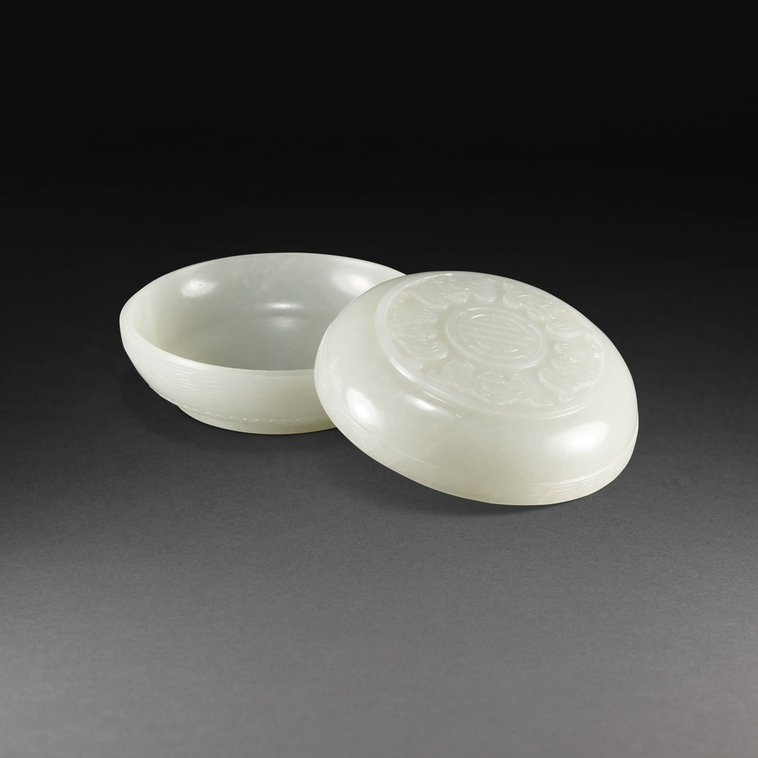 A WHITE JADE ‘SHOU AND BAT’ CIRCULAR BOX AND COVER, QING DYNASTY, 18TH ...