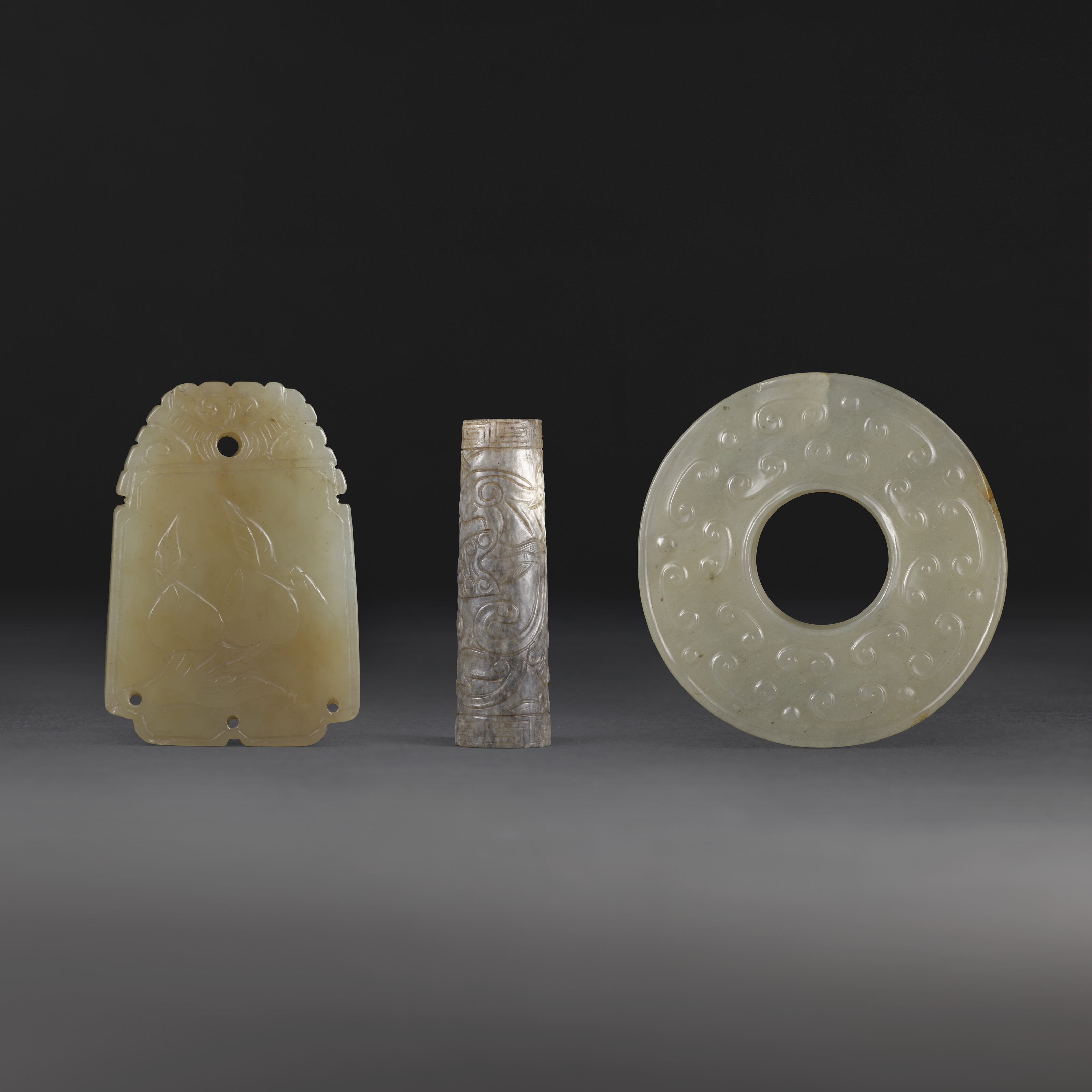 A JADE ‘PEACHES’ PLAQUE, A JADE BI DISC AND A JADE ‘DRAGON’ CYLINDER ...