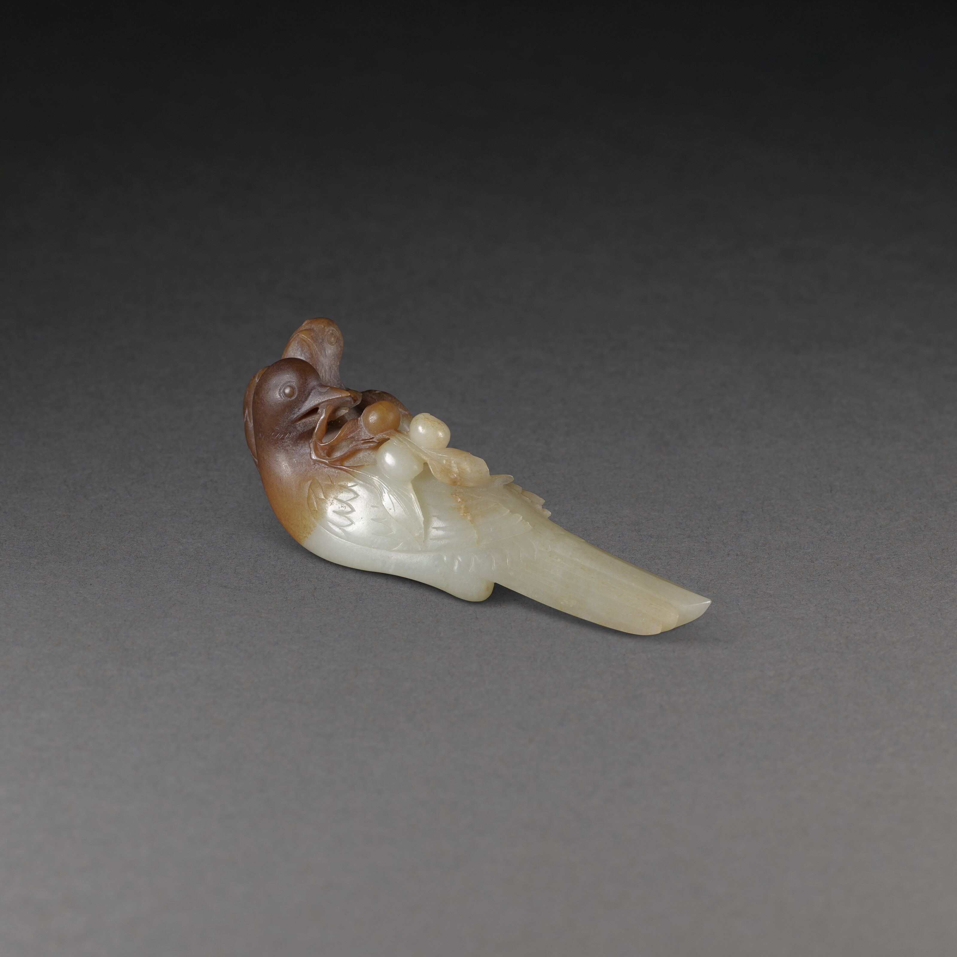 A RUSSET AND WHITE JADE ‘BIRDS AND PEACHES’ GROUP, MING-QING DYNASTY ...