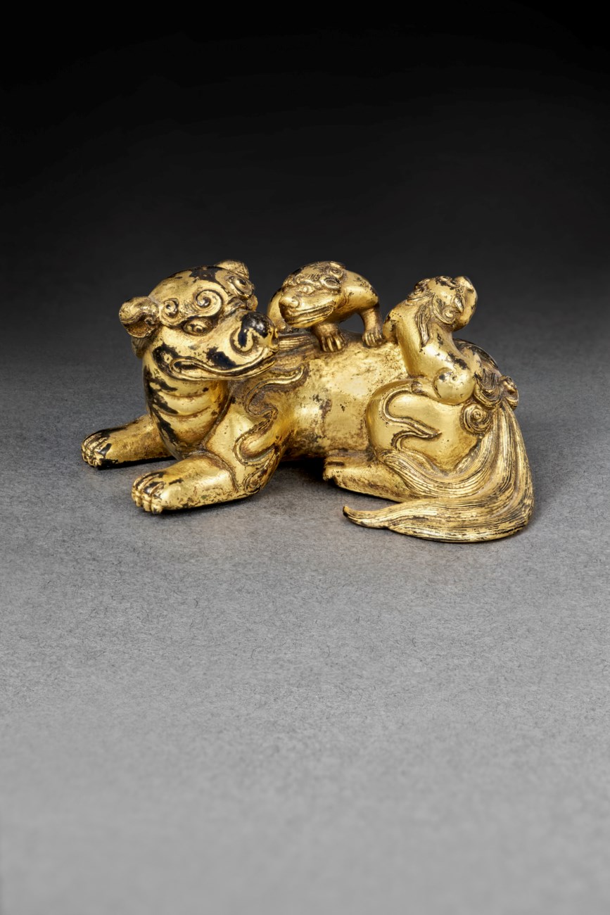 A SMALL WELL-CAST GILT-BRONZE FIGURE OF A LION WITH CUBS, MING DYNASTY ...