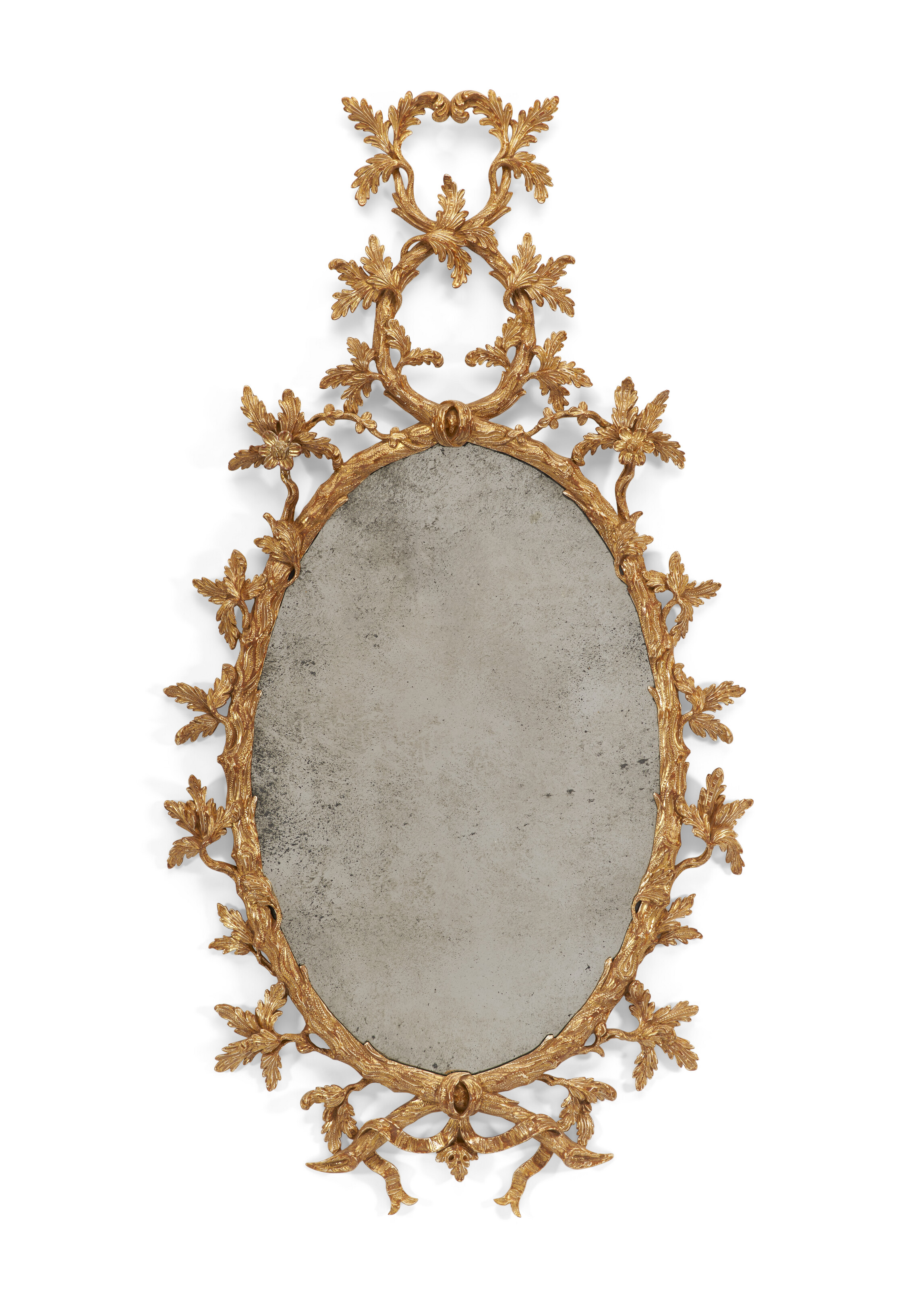 A GEORGE III GILTWOOD OVAL MIRROR, AFTER A DESIGN BY JOHN LINNELL ...