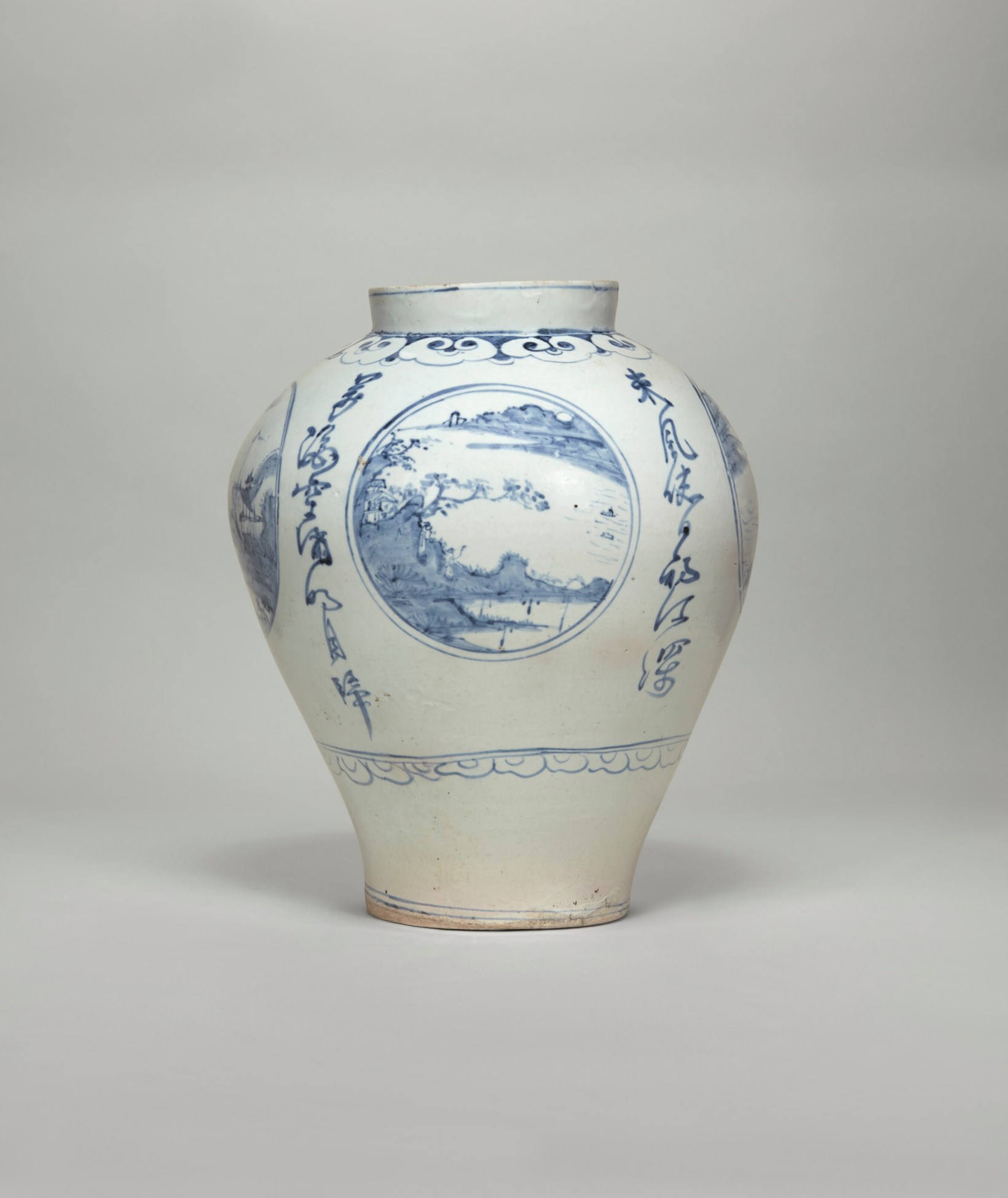 A BLUE AND WHITE PORCELAIN JAR WITH FOUR LANDSCAPE ROUNDELS AND A POEM ...