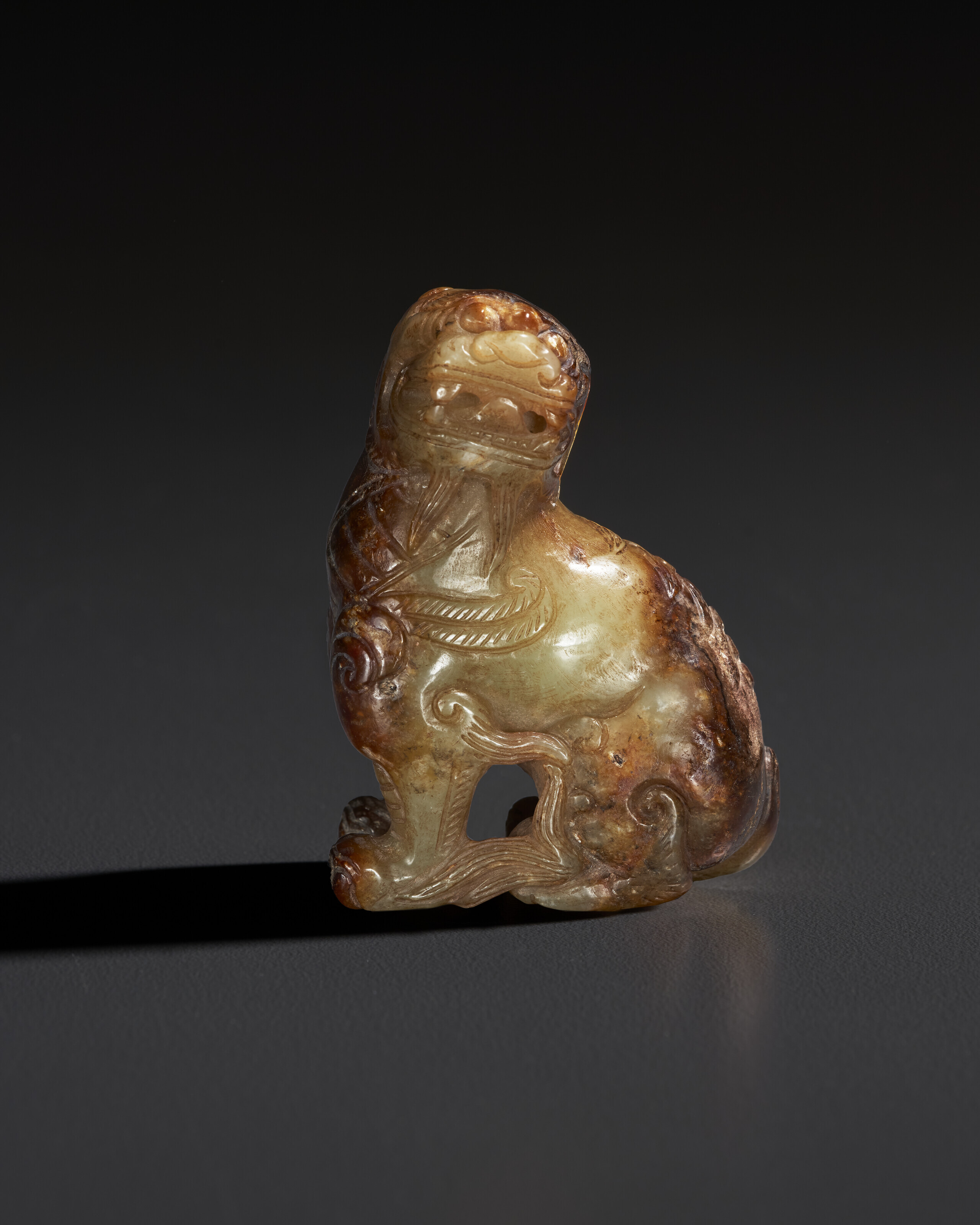 A BEIGE AND BROWN JADE MYTHICAL BEAST, CHINA, LATE MING-EARLY QING ...