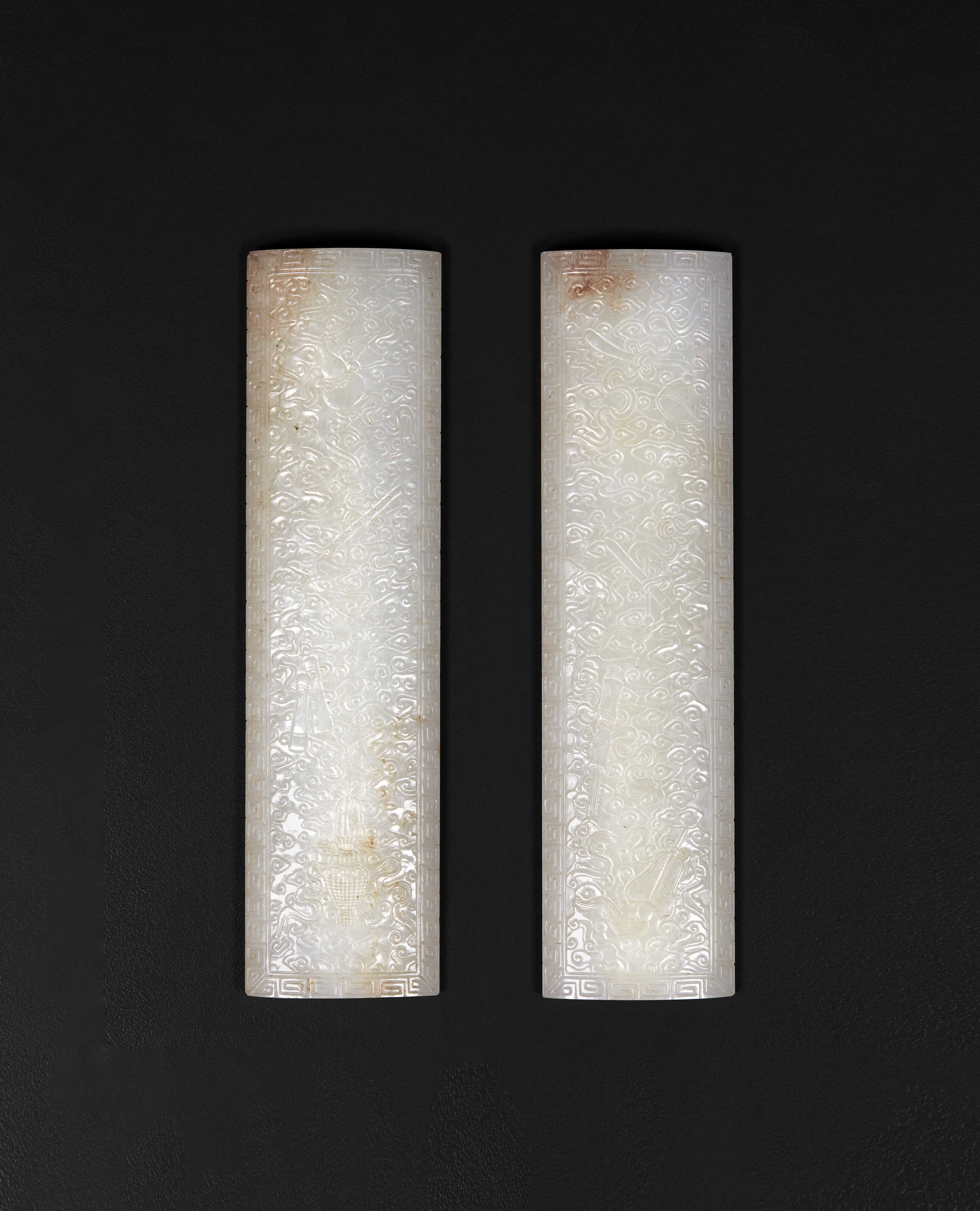 A PAIR OF CARVED WHITE JADE 'DAOIST EMBLEMS' WRIST RESTS, CHINA ...