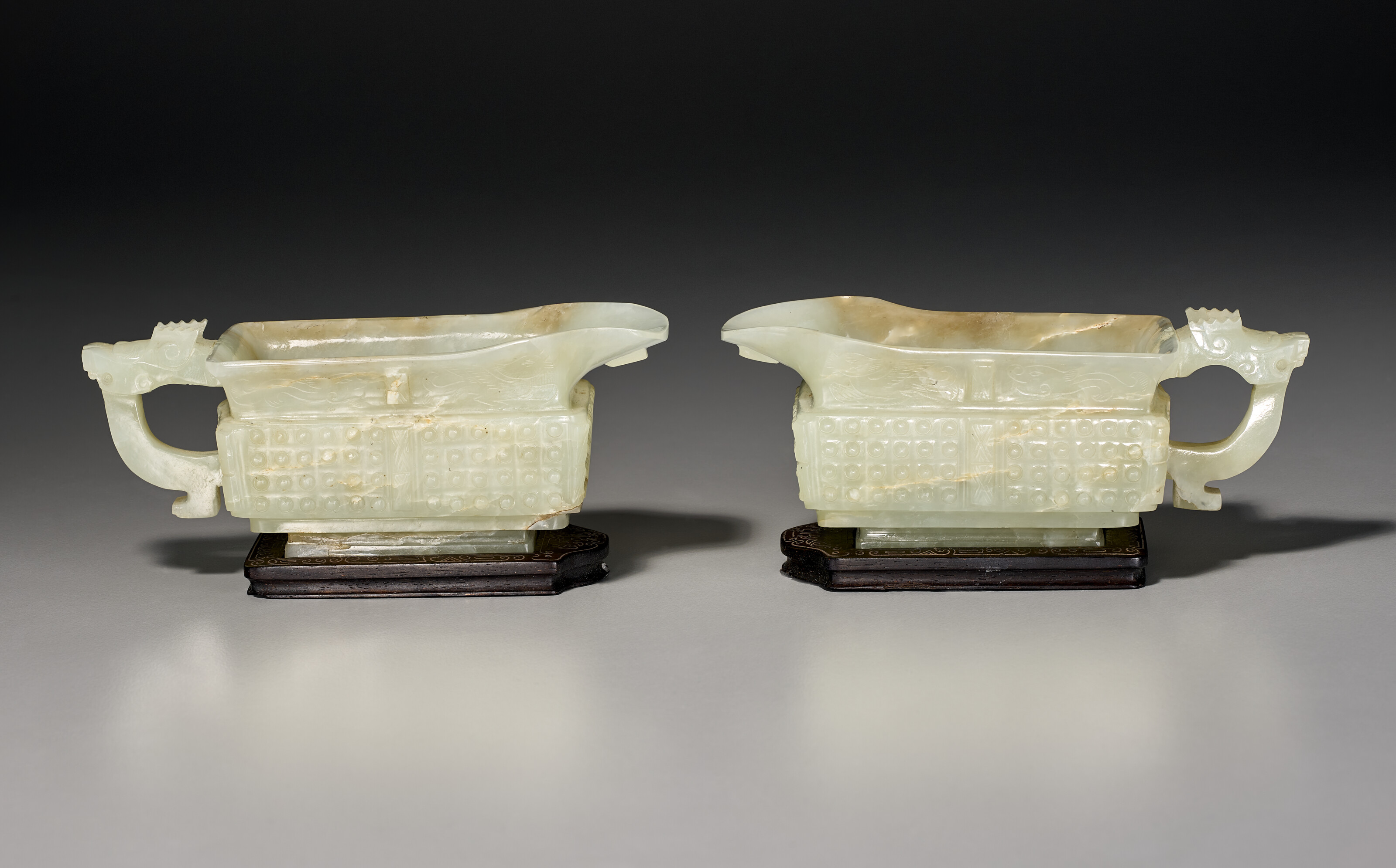 A PAIR OF GREENISH-WHITE AND RUSSET JADE POURING VESSELS, CHINA ...