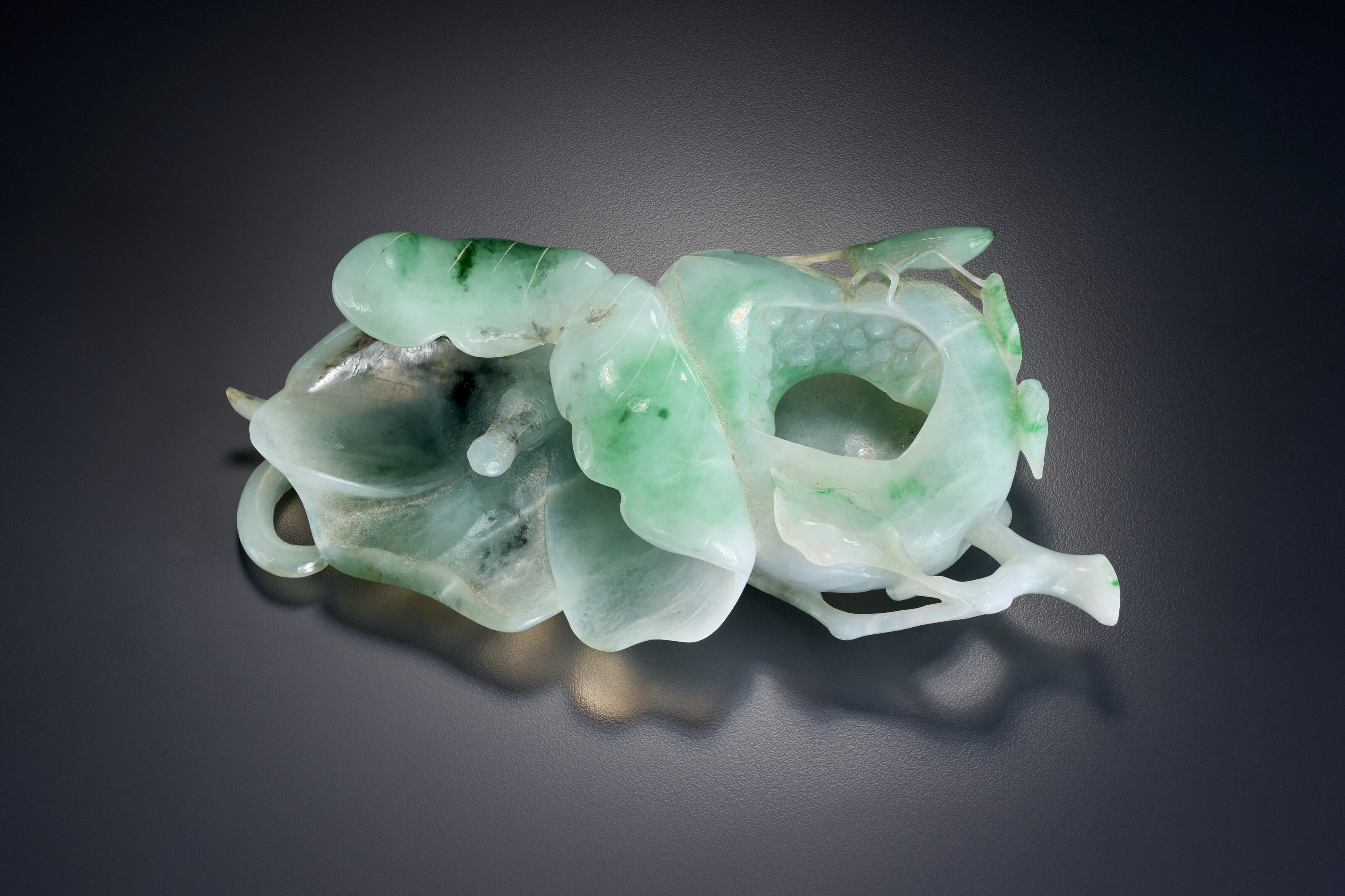 A GREEN AND PALE GREY JADEITE POMEGRANATE AND FLOWER-FORM WASHER, CHINA ...