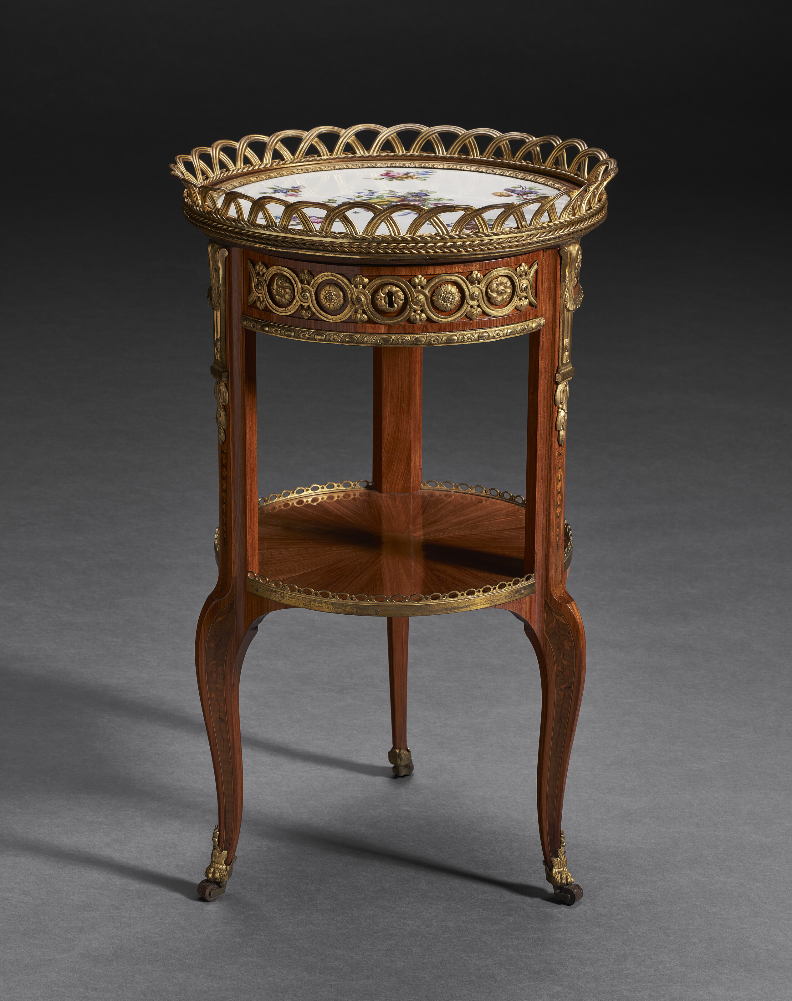 A LATE LOUIS XV ORMOLU AND SEVRES PORCELAIN-MOUNTED TULIPWOOD GUERIDON ...