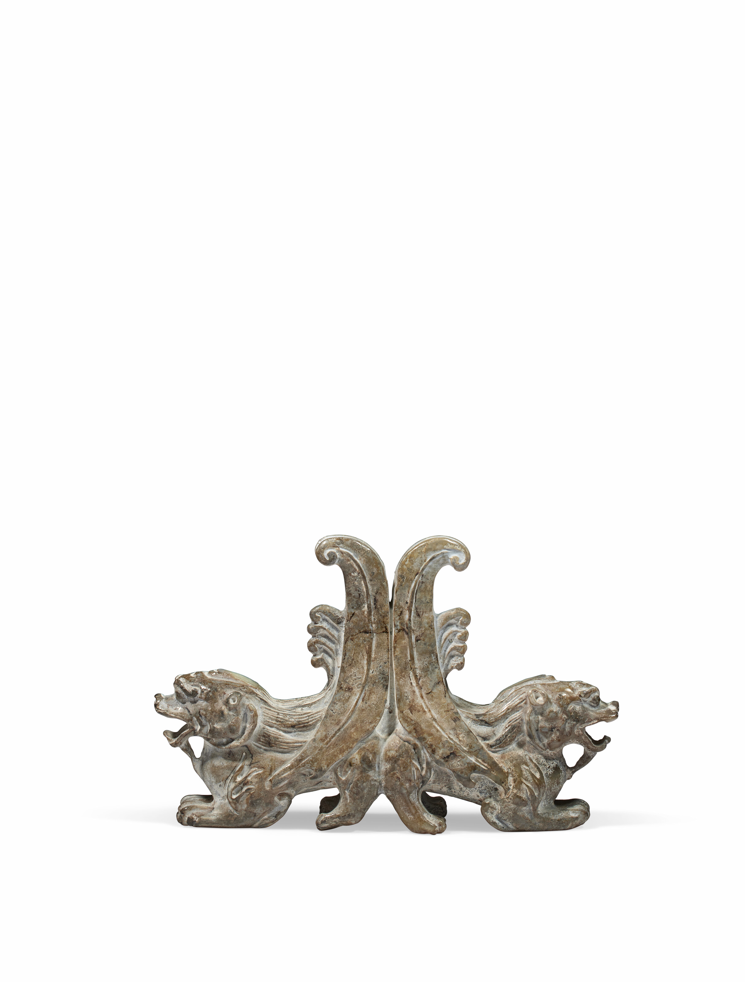 A MOTTLED JADE CARVING OF TWO CONJOINED MYTHICAL BEASTS, CHINA | Christie’s