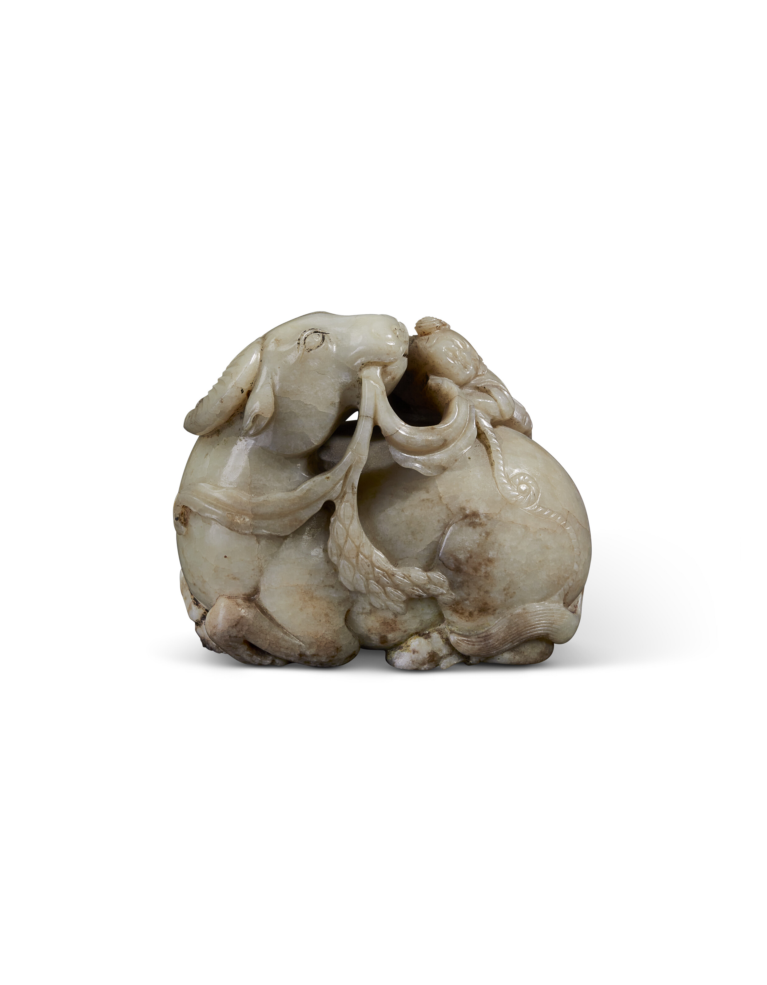 A MOTTLED CREAMY BEIGE AND PALE BROWN JADE CARVING OF A BUFFALO AND A ...