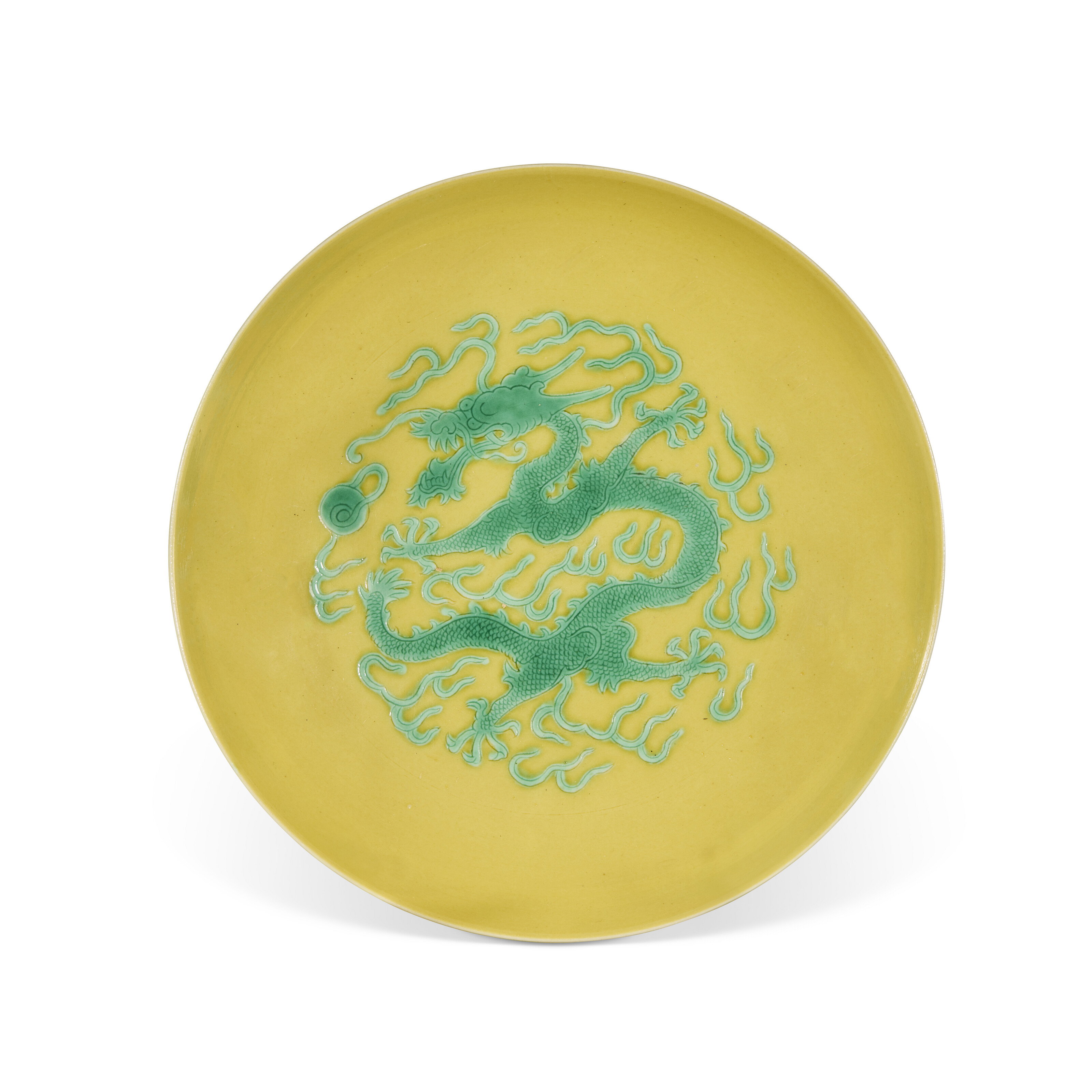 A YELLOW-GROUND GREEN-ENAMELLED INCISED 'DRAGON' DISH, CHINA, QING ...
