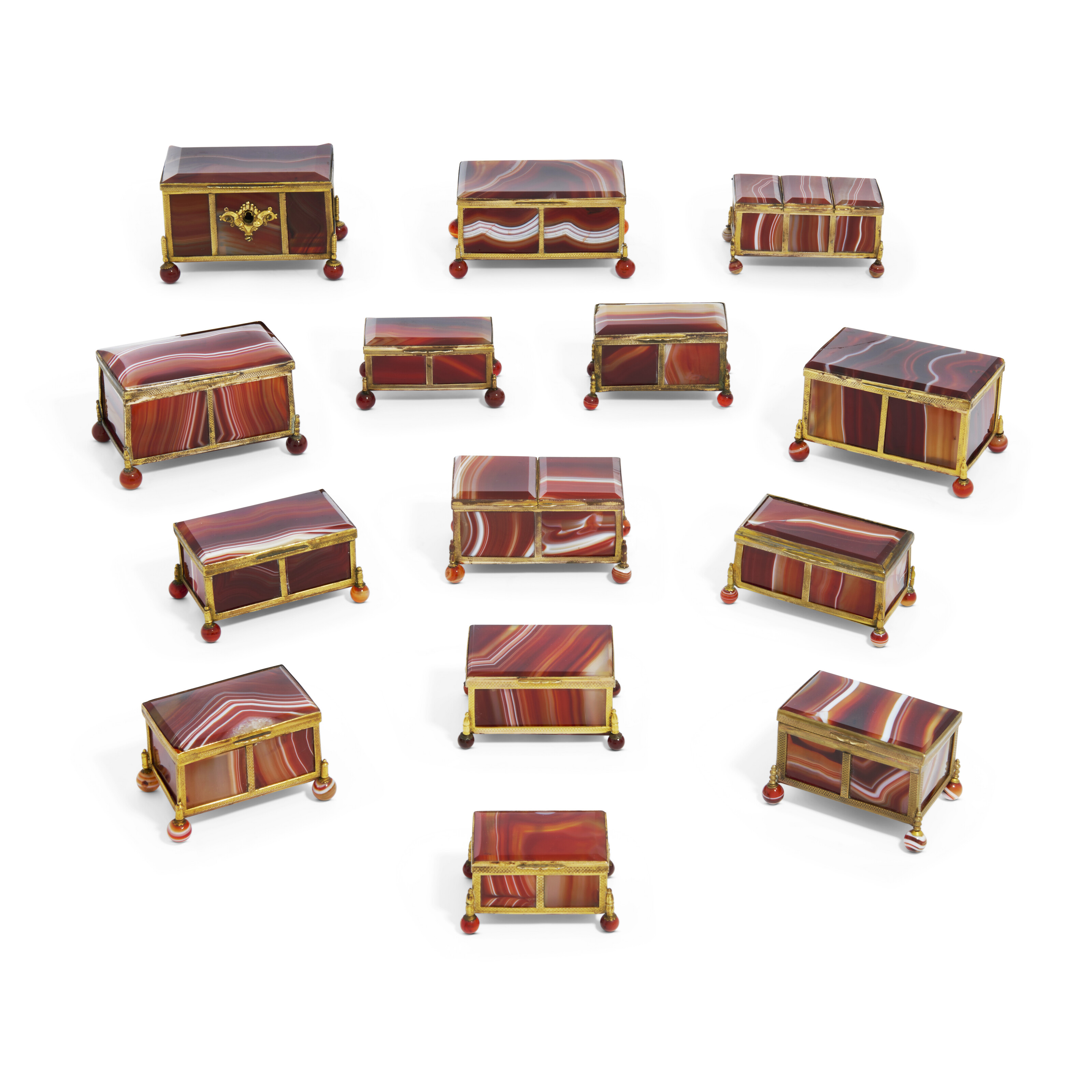 FOURTEEN CONTINENTAL GILT-METAL MOUNTED RED AGATE CASKETS, FRENCH OR ...