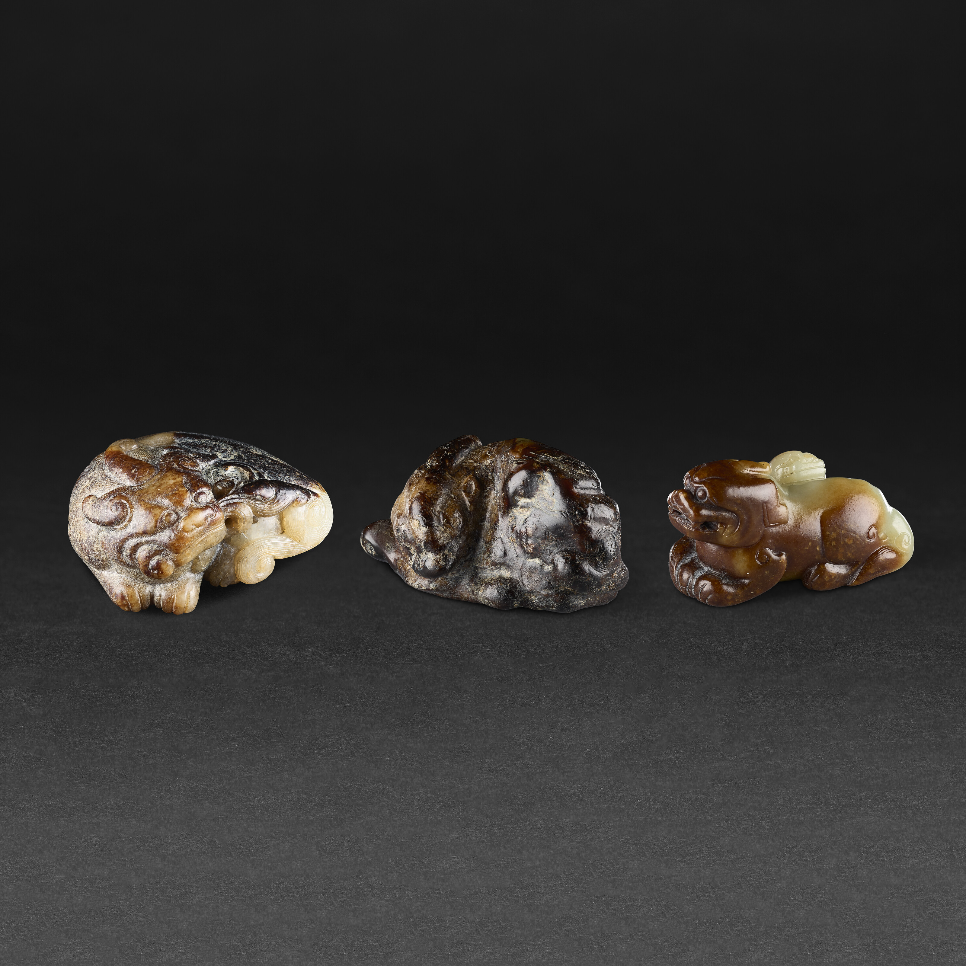 A GROUP OF THREE JADE CARVINGS OF MYTHICAL BEASTS, MING DYNASTY (1368 ...