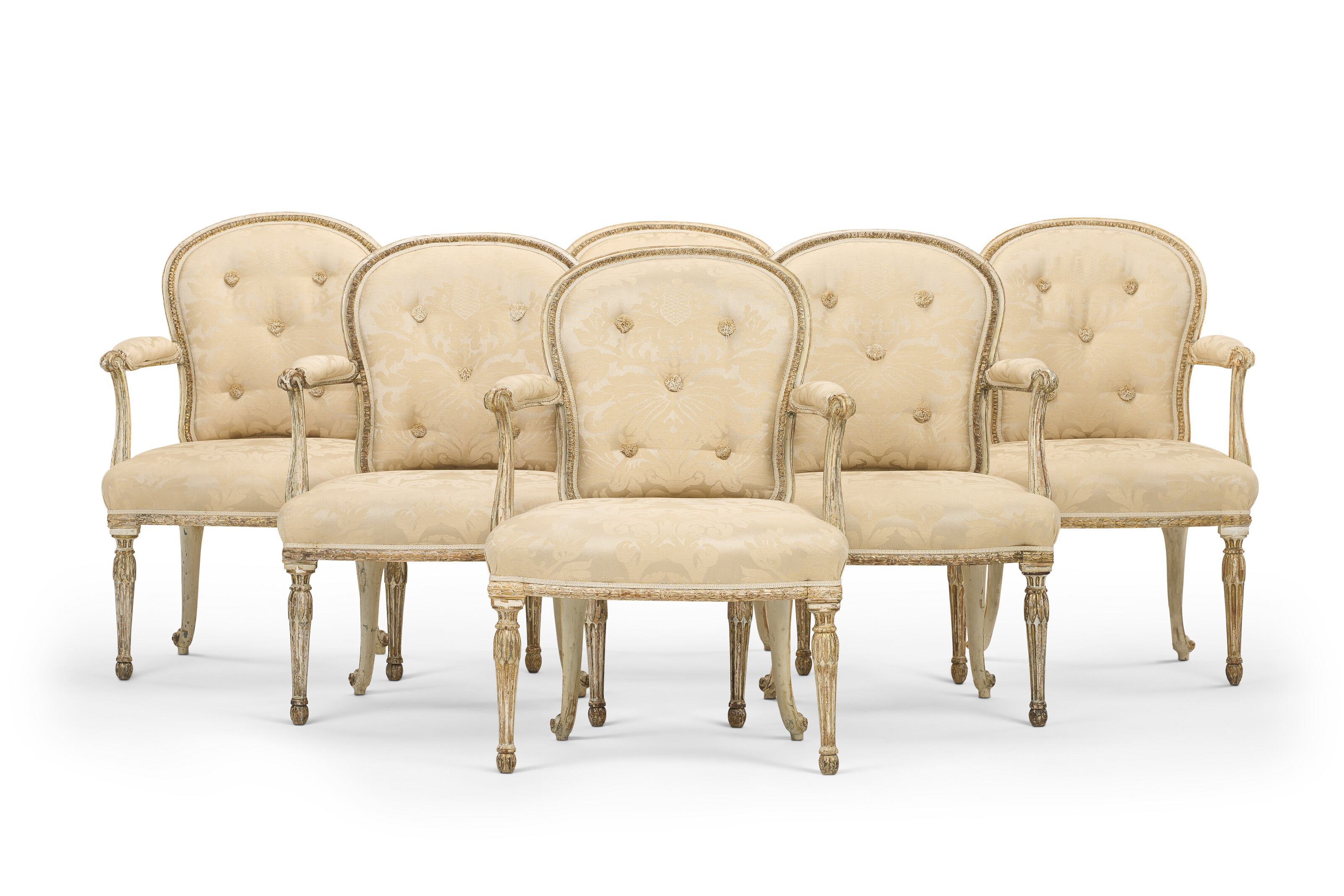 A SET OF SIX GEORGE III CREAM-PAINTED AND PARCEL-GILT OPEN ARMCHAIRS ...