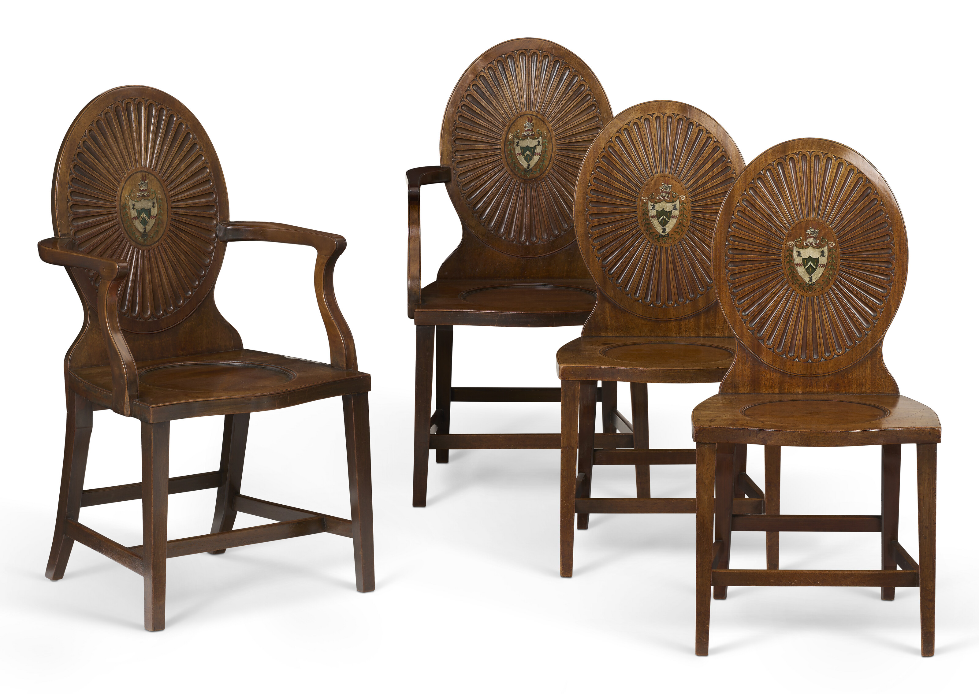 A SET OF FOUR GEORGE III POLYCHROME-DECORATED MAHOGANY HALL CHAIRS ...