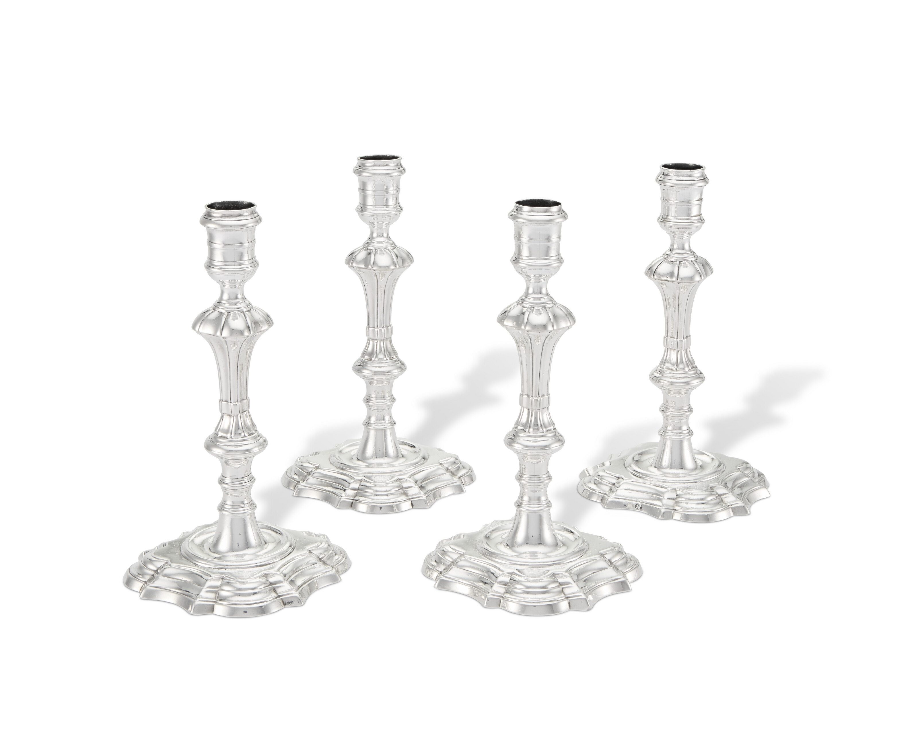 A SET OF FOUR GEORGE II IRISH SILVER CANDLESTICKS, MARK OF JOHN ...