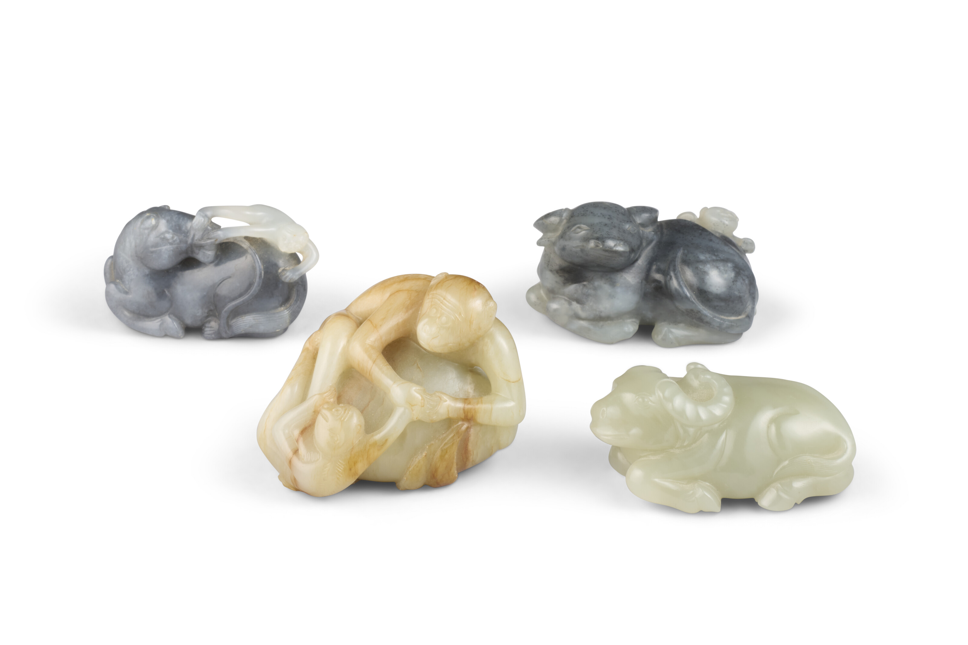 A CELADON JADE BUFFALO, A CELADON AND RUSSET JADE 'TWO MONKEYS ON A ...