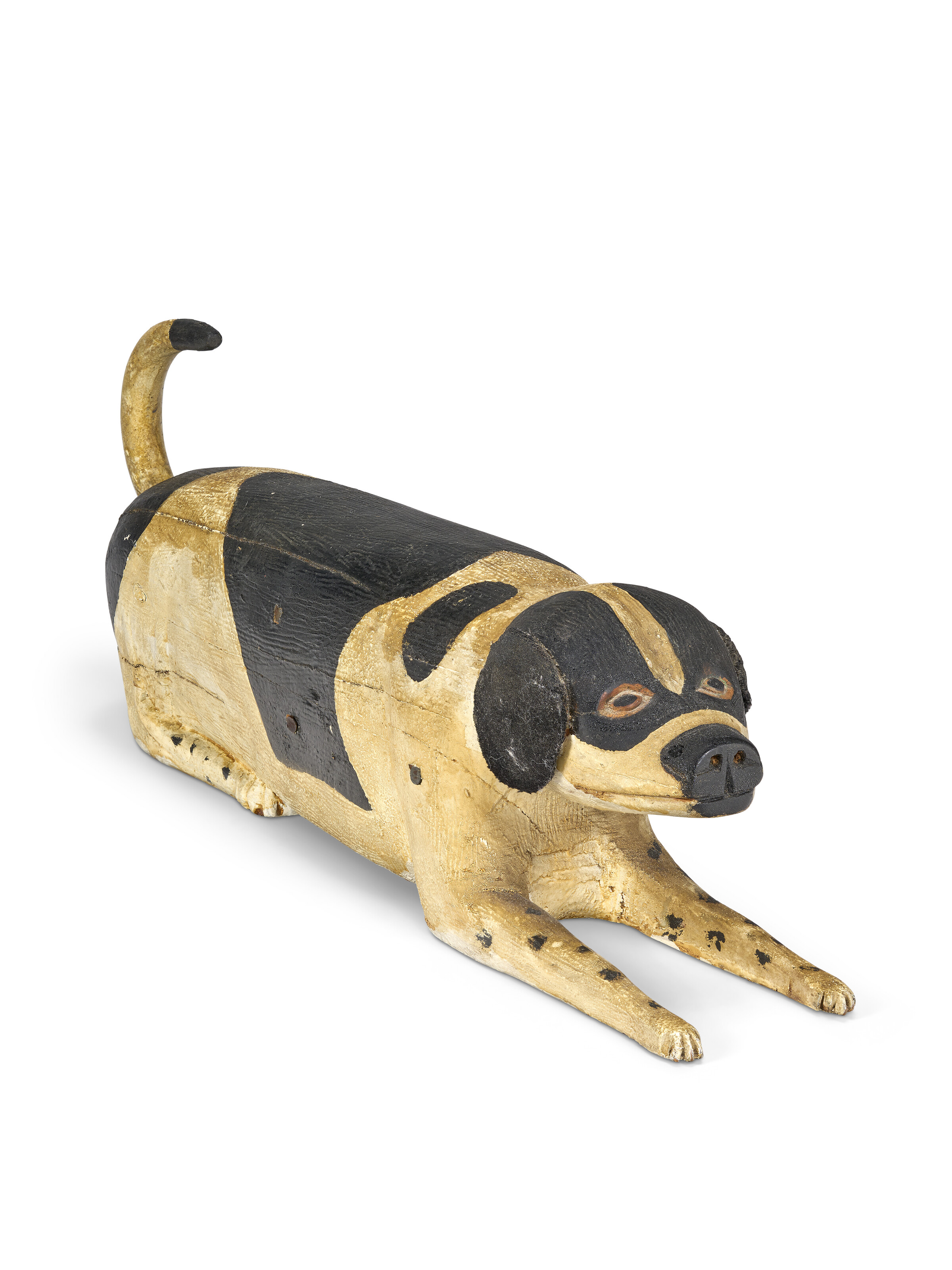 A CARVED AND PAINT-DECORATED WOOD RECLINING DOG, AMERICAN, LATE 19TH ...