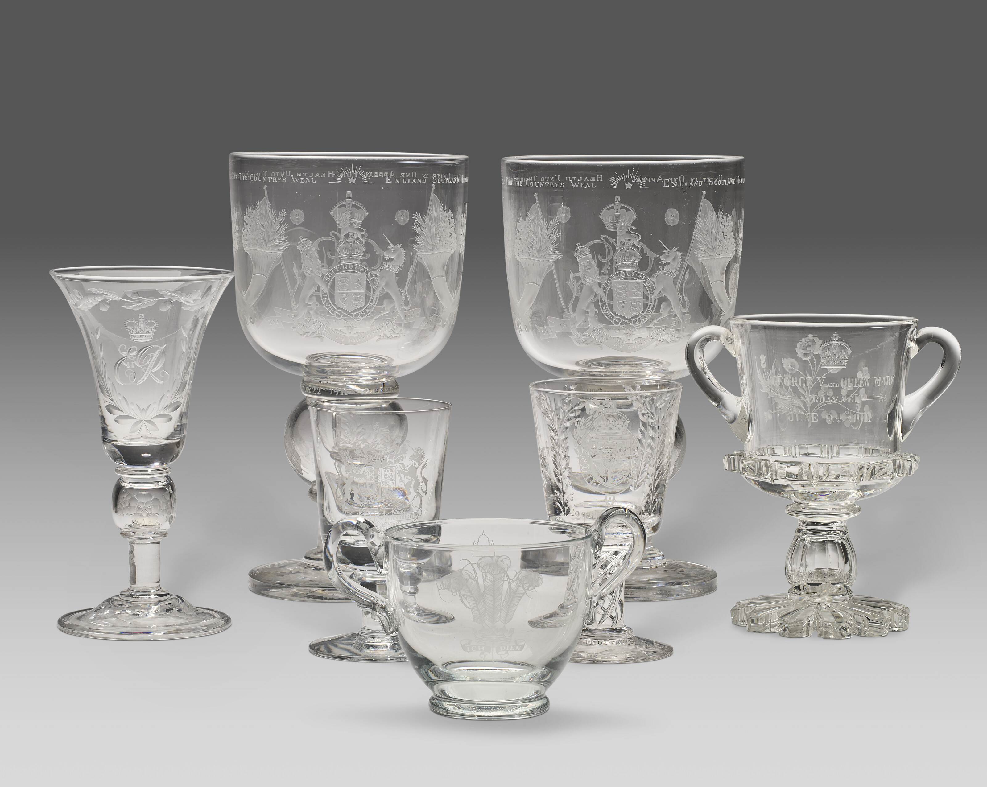 A PAIR OF LARGE ENGLISH ENGRAVED GLASS GOBLETS COMMEMORATING GEORGE V'S ...